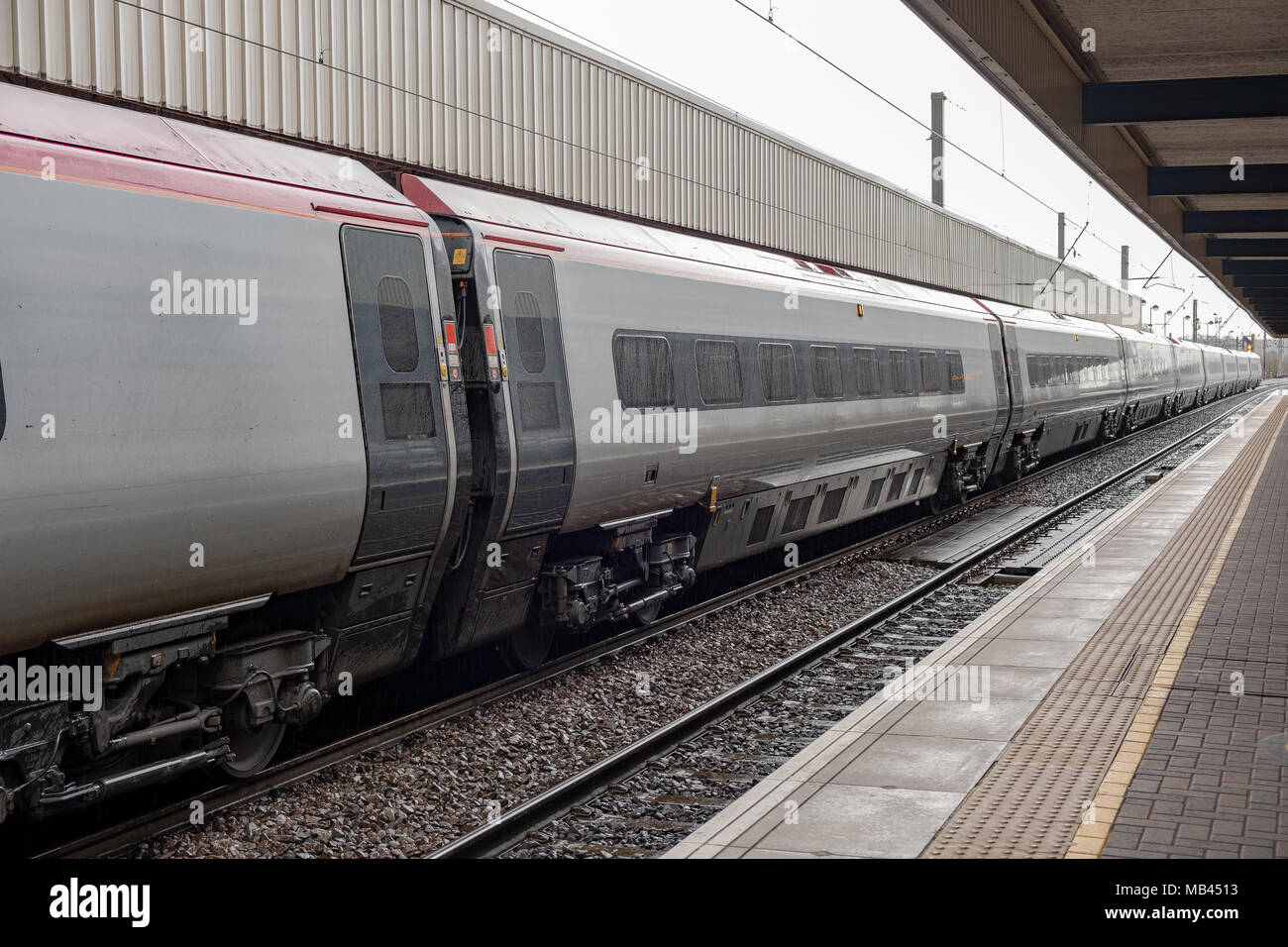 A highspeed passenger train stands at the platform in the rain Stock ...