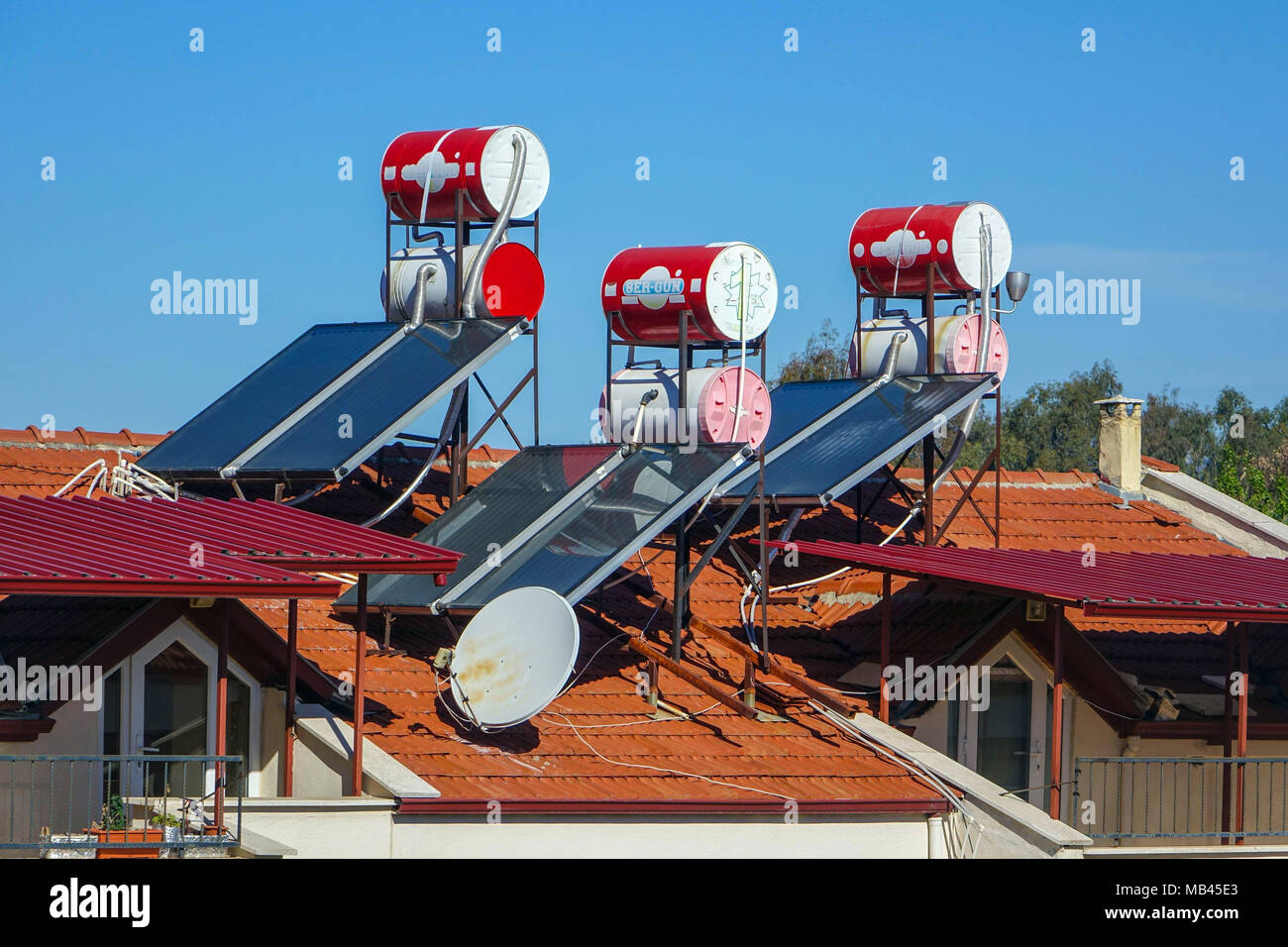 Solar panels and red water tanks on rooftop, Fethiye, Turkey Stock ...