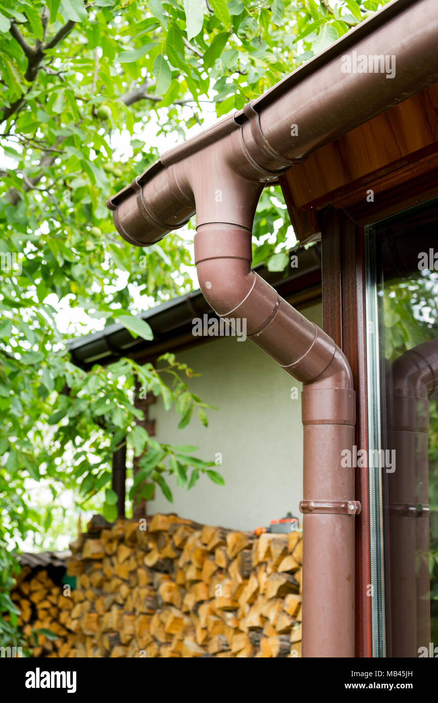 plastic gutter for draining rainwater at the corner of a residential ...