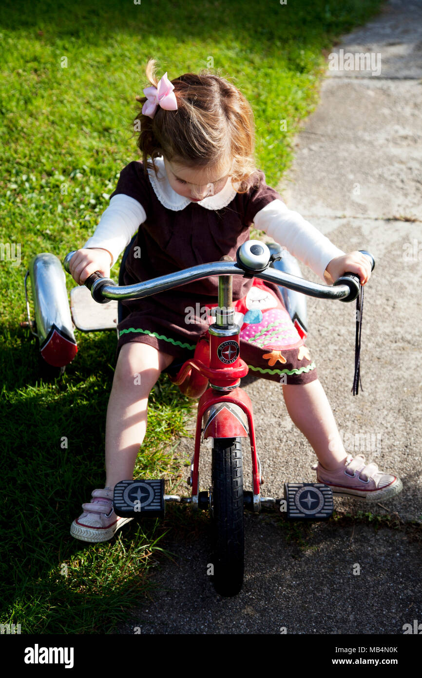 Girl riding tricycle hi-res stock photography and images - Alamy