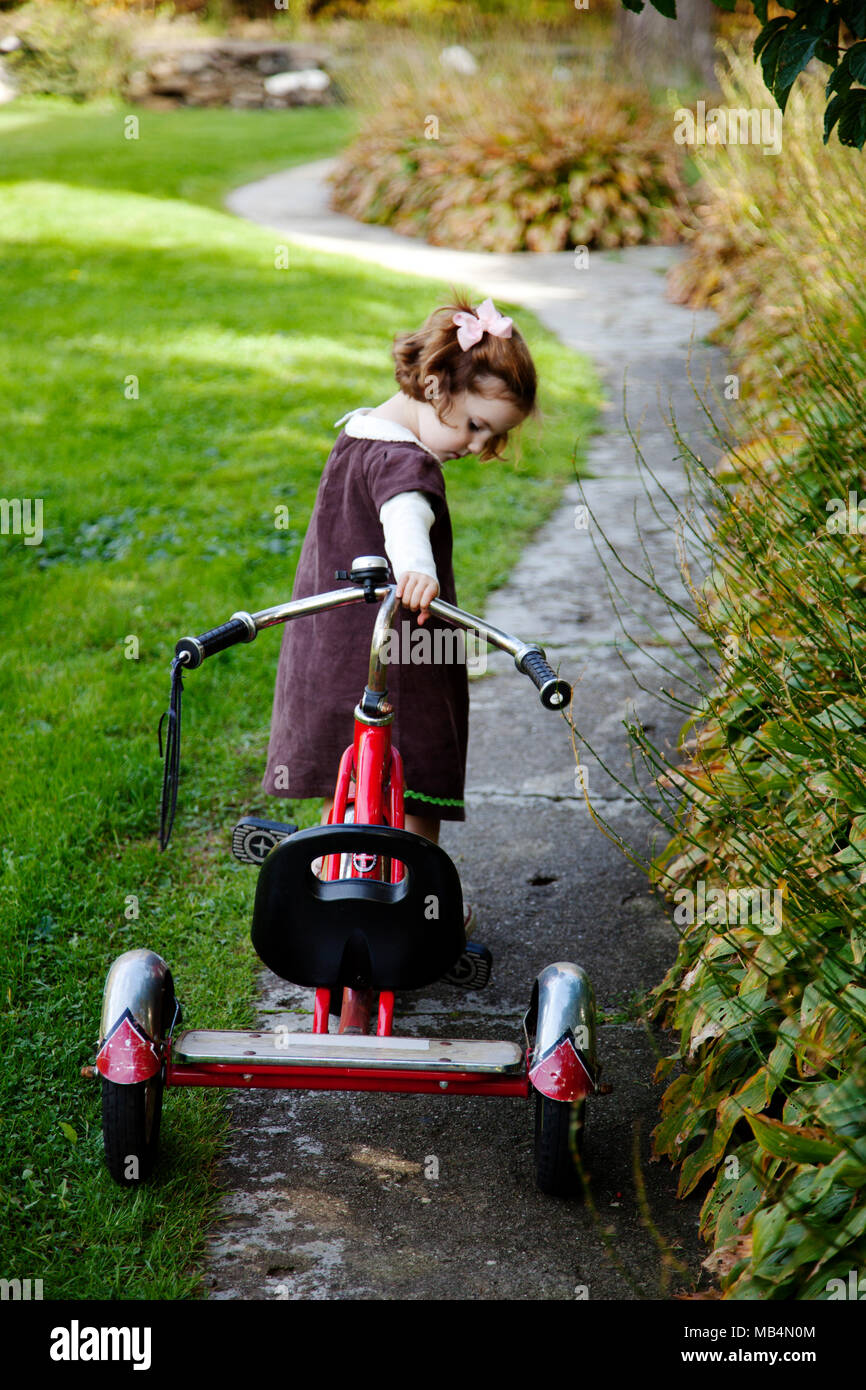 Girl tricycle pulling hi-res stock photography and images - Alamy