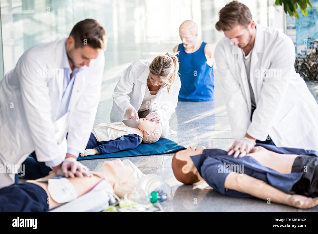 MODEL RELEASED. Doctors undertaking CPR training on dummies Stock Photo ...