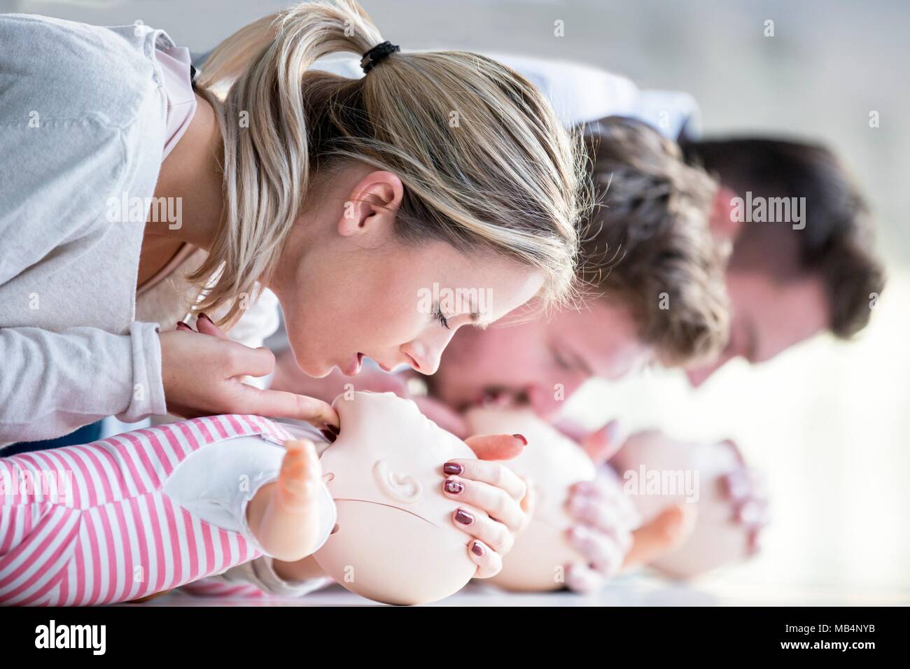 MODEL RELEASED. Doctor practising infant CPR on training dummies Stock ...