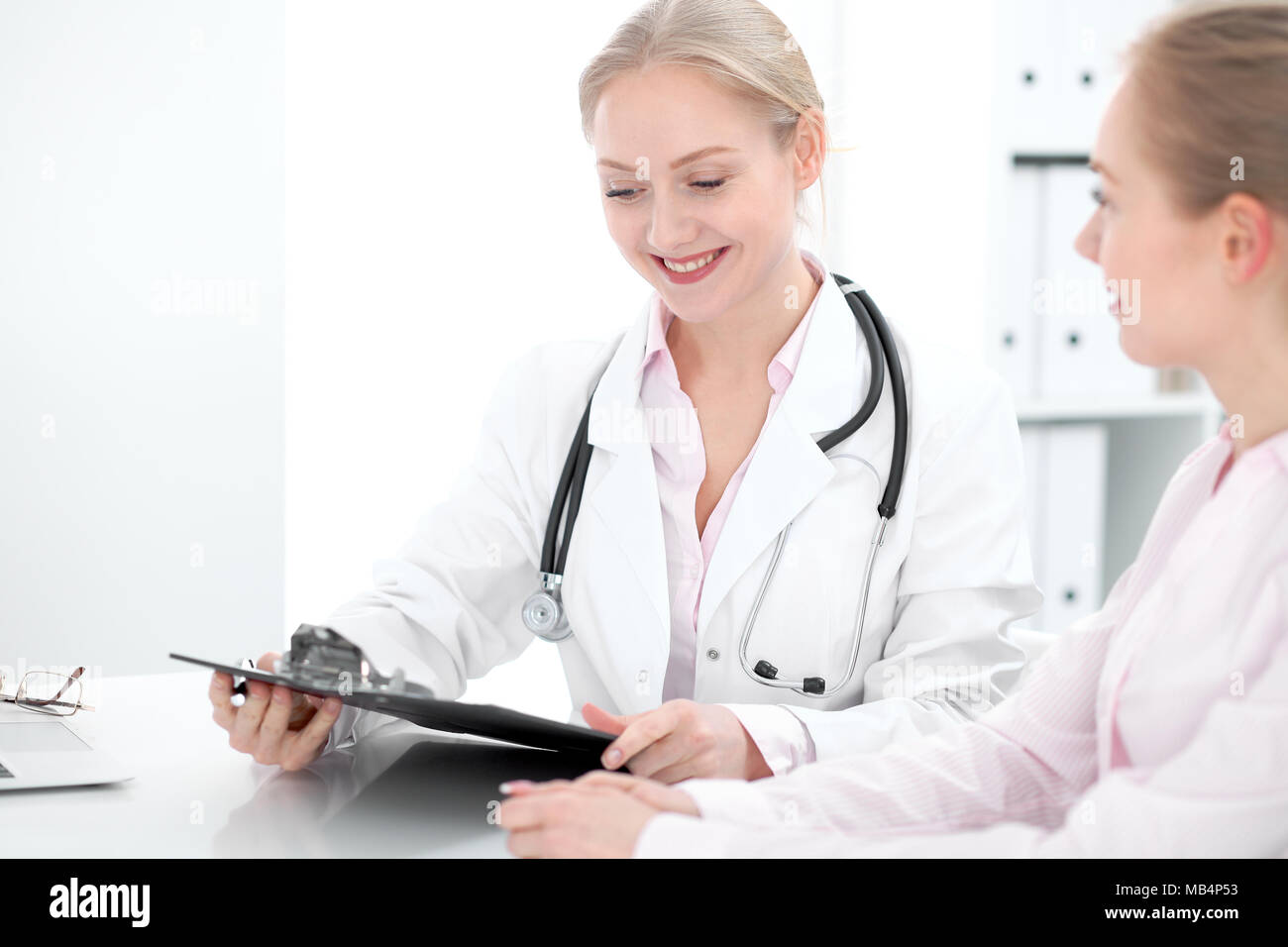 Blonde female doctor and patient during personal consulting in hospital ...