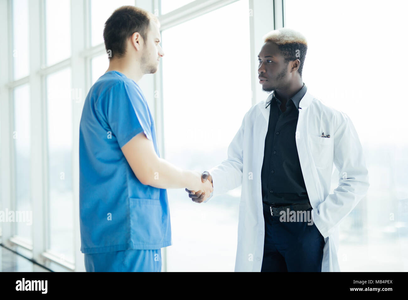 Medical handshake. Doctoral meeting. Two confident doctor standing in ...