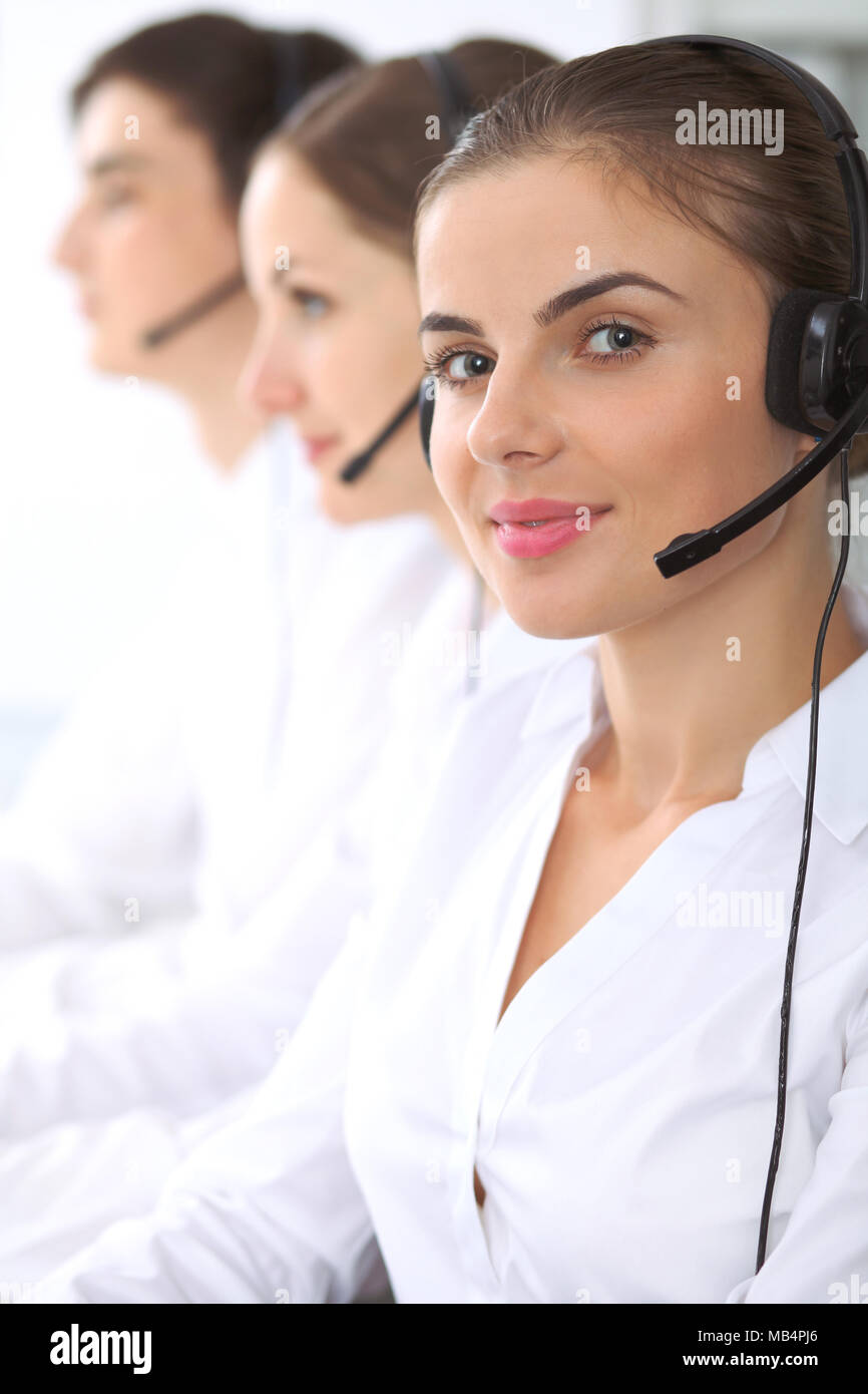 Call center. Focus on beautiful woman in headset Stock Photo - Alamy