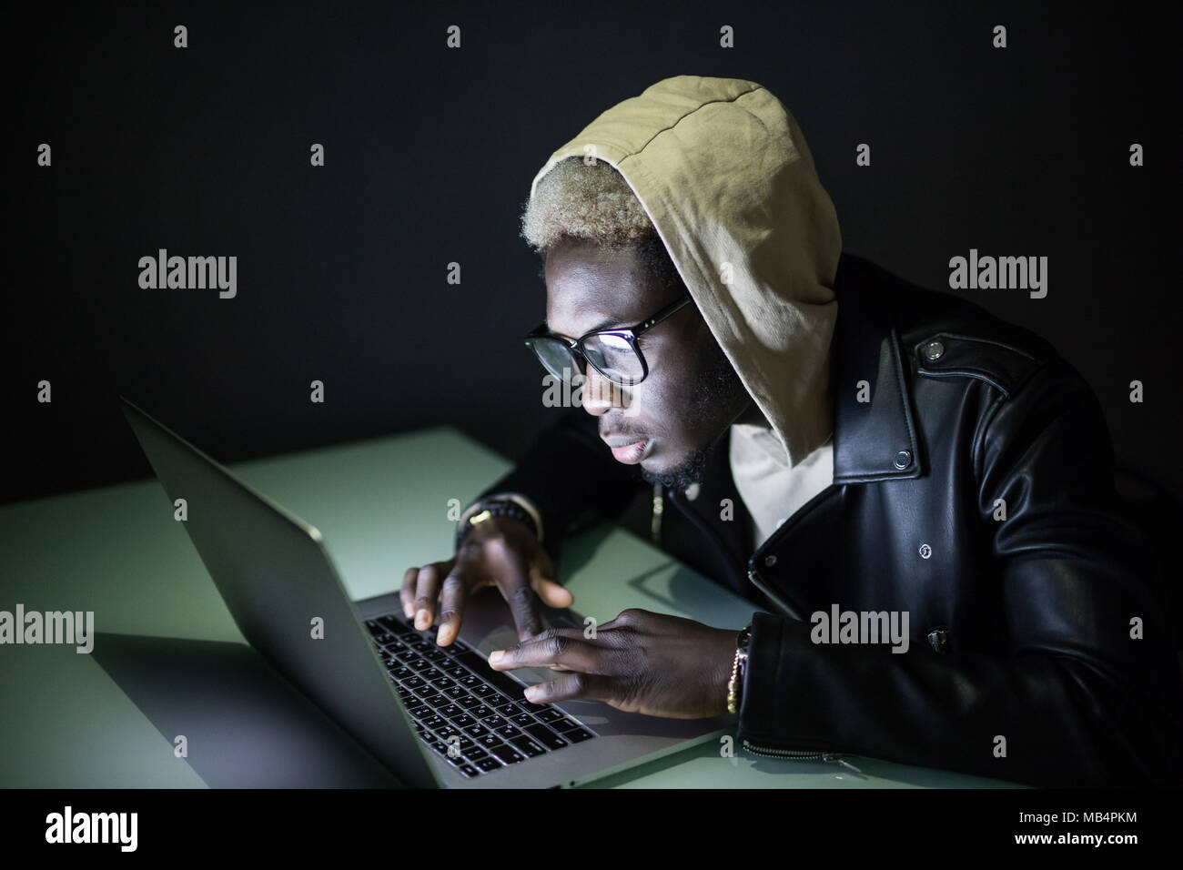 Afro american hacker with no face in the darkness, breaks the access to ...