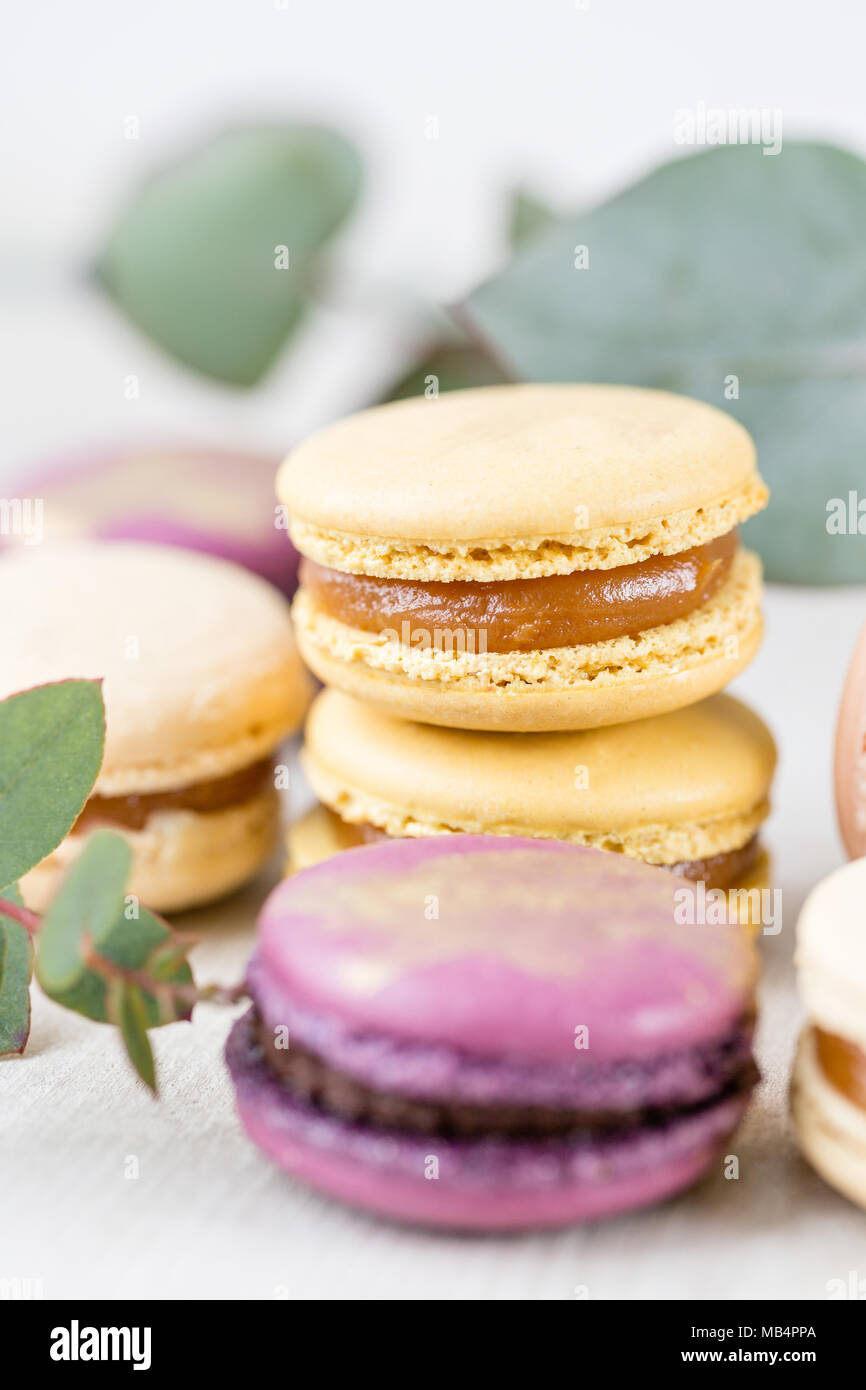 Close-up colorful French or Italian macaron on white wooden table ...