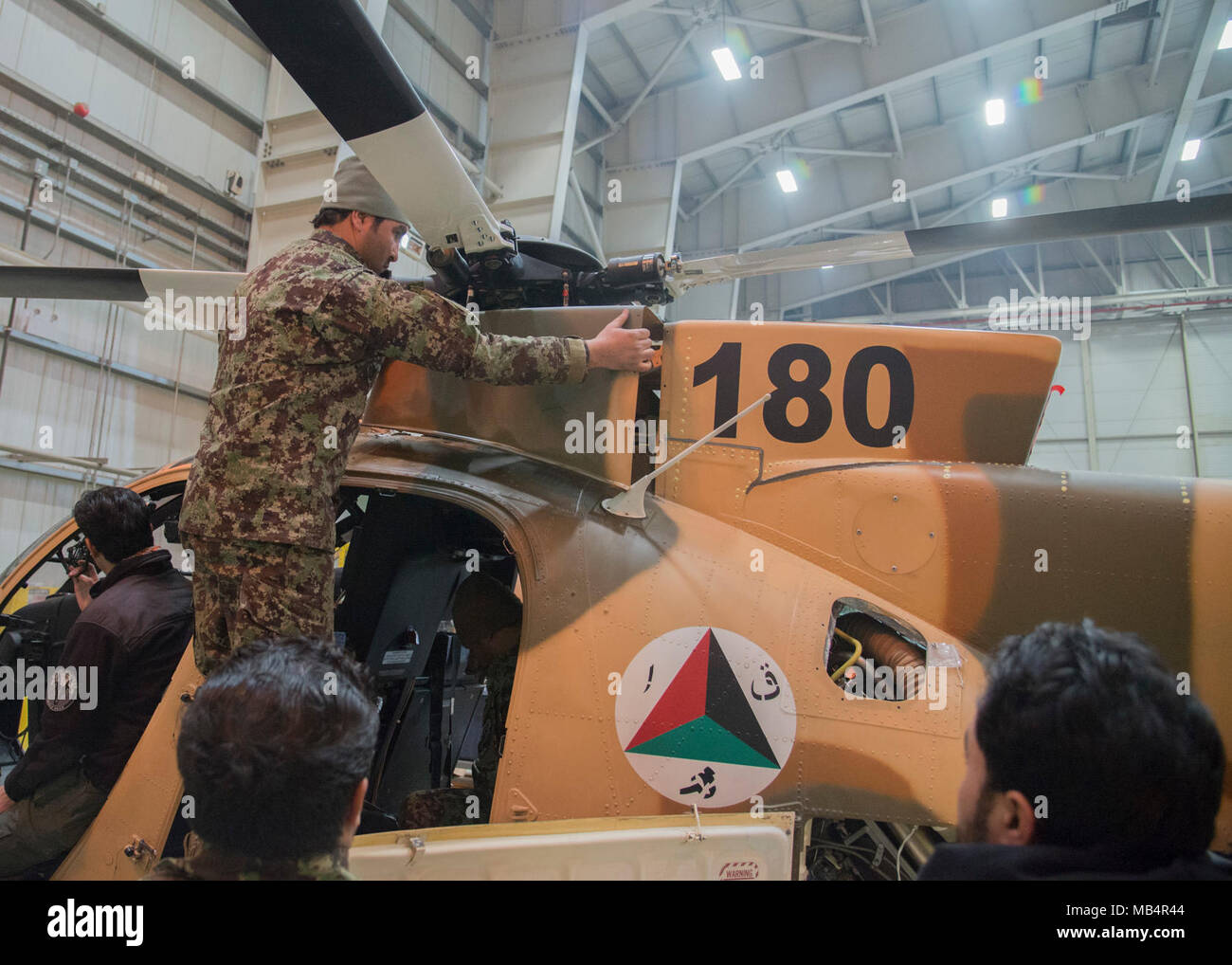 An Afghan Air Force MD-530 maintainer replaces a panel on an MD-530 ...