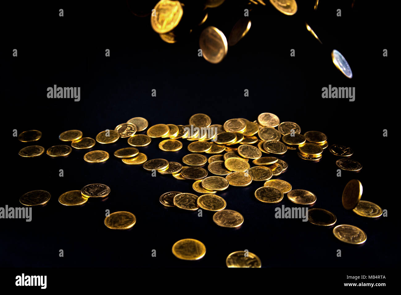 Falling gold coins money in dark background, business concept idea ...