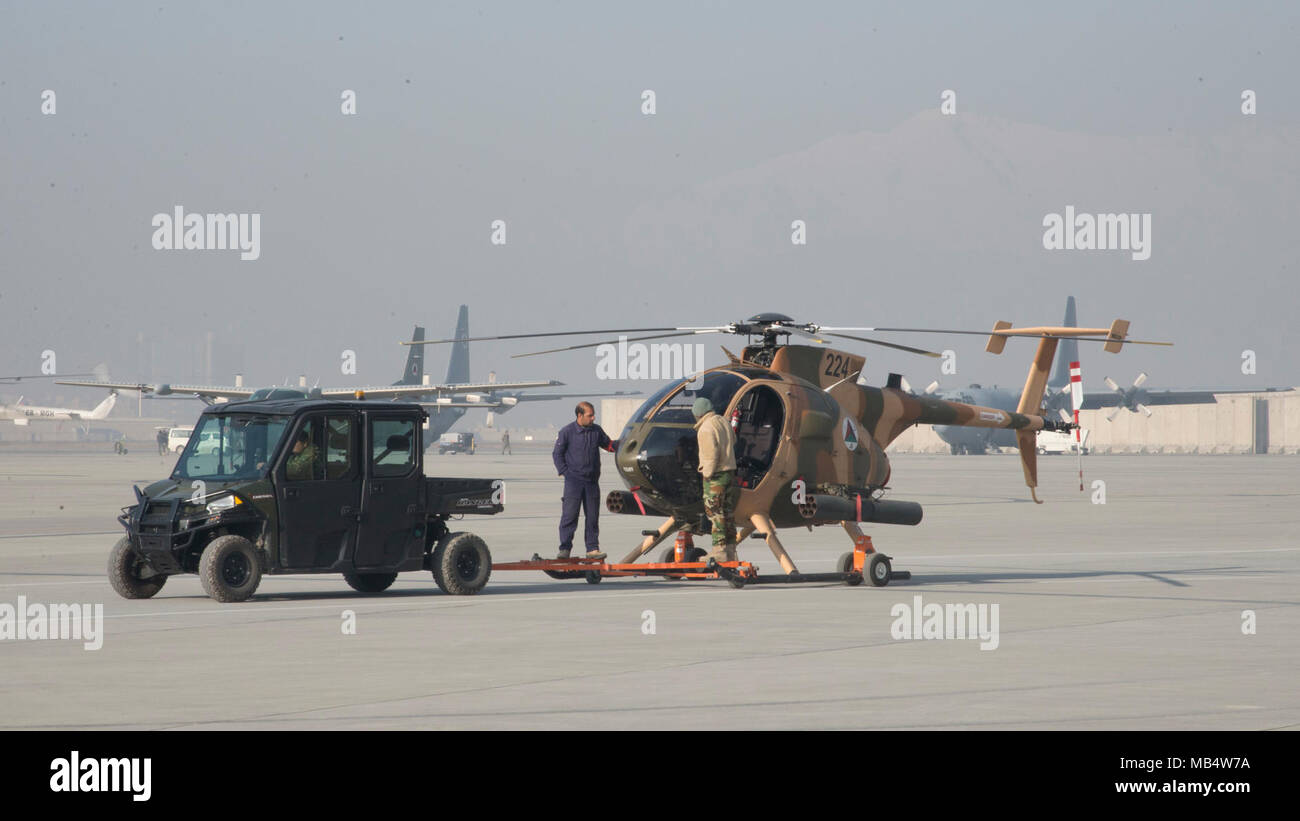 An Afghan Air Force MD-530 is transported across the flight line ...