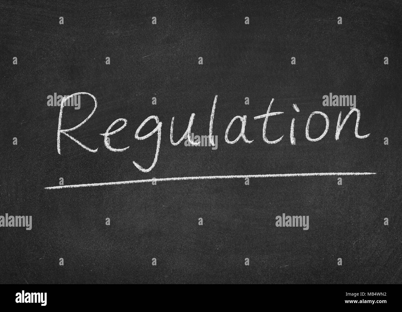 regulation concept word on a blackboard background Stock Photo - Alamy