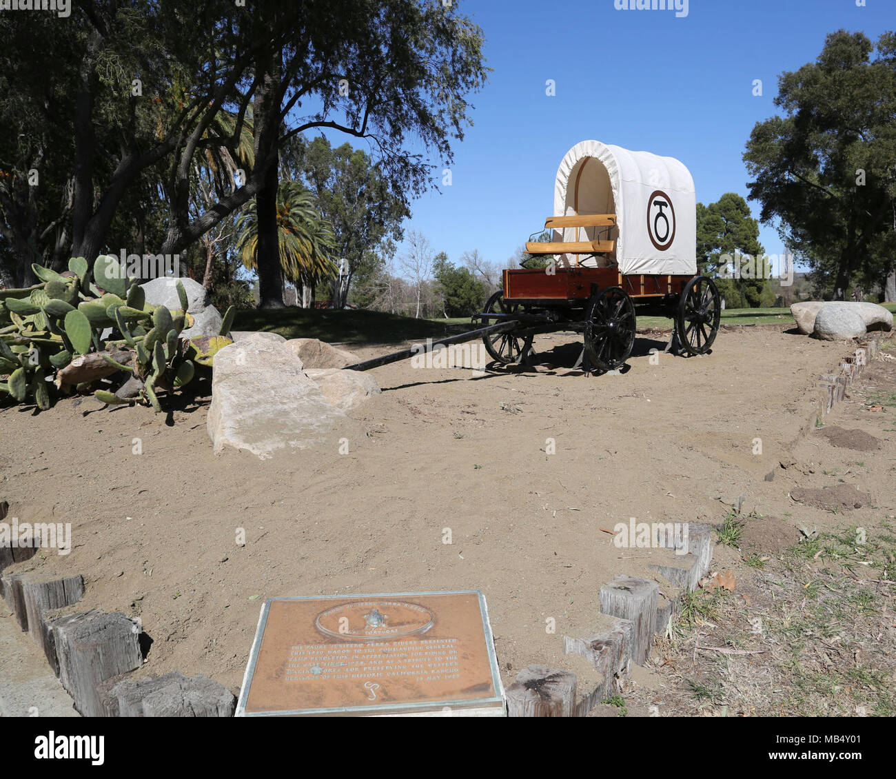 A restored covered wagon is installed in front of the Santa Margarita ...