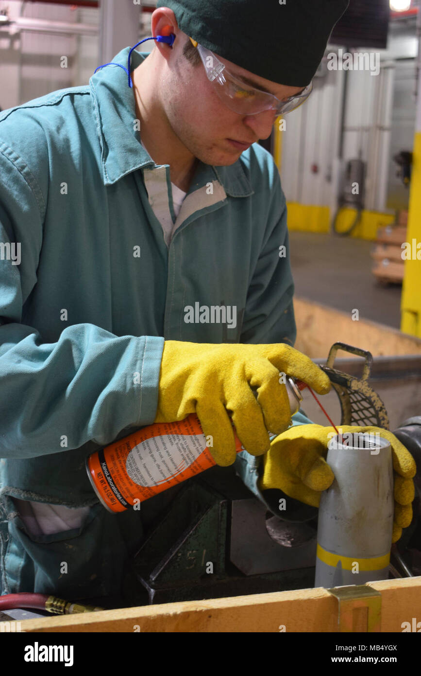 Crane Army Ammunition Activity employees disassemble 76 mm white ...
