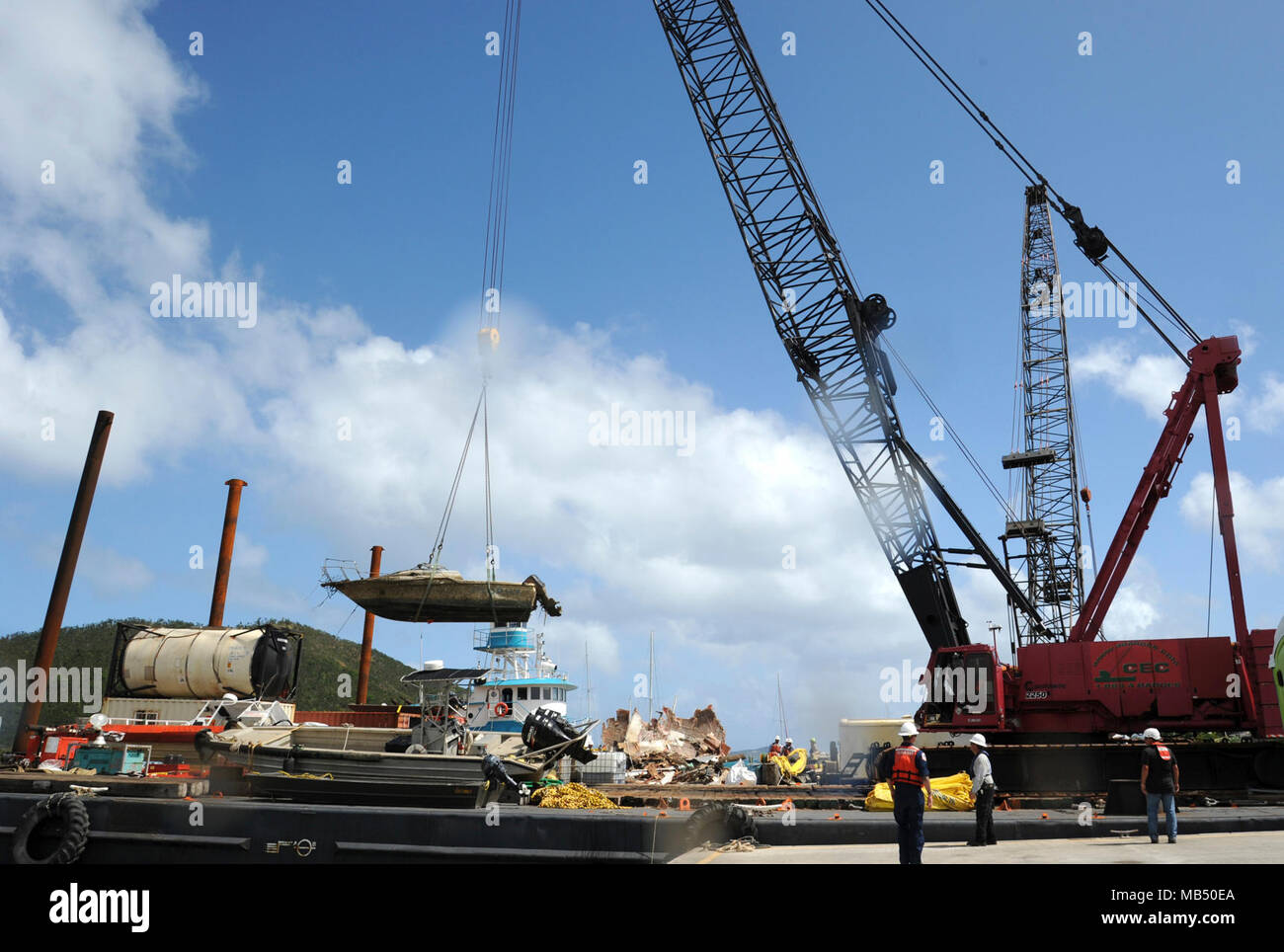 Members of Resolve Marine Group transfer a boat identified as STT060 to ...
