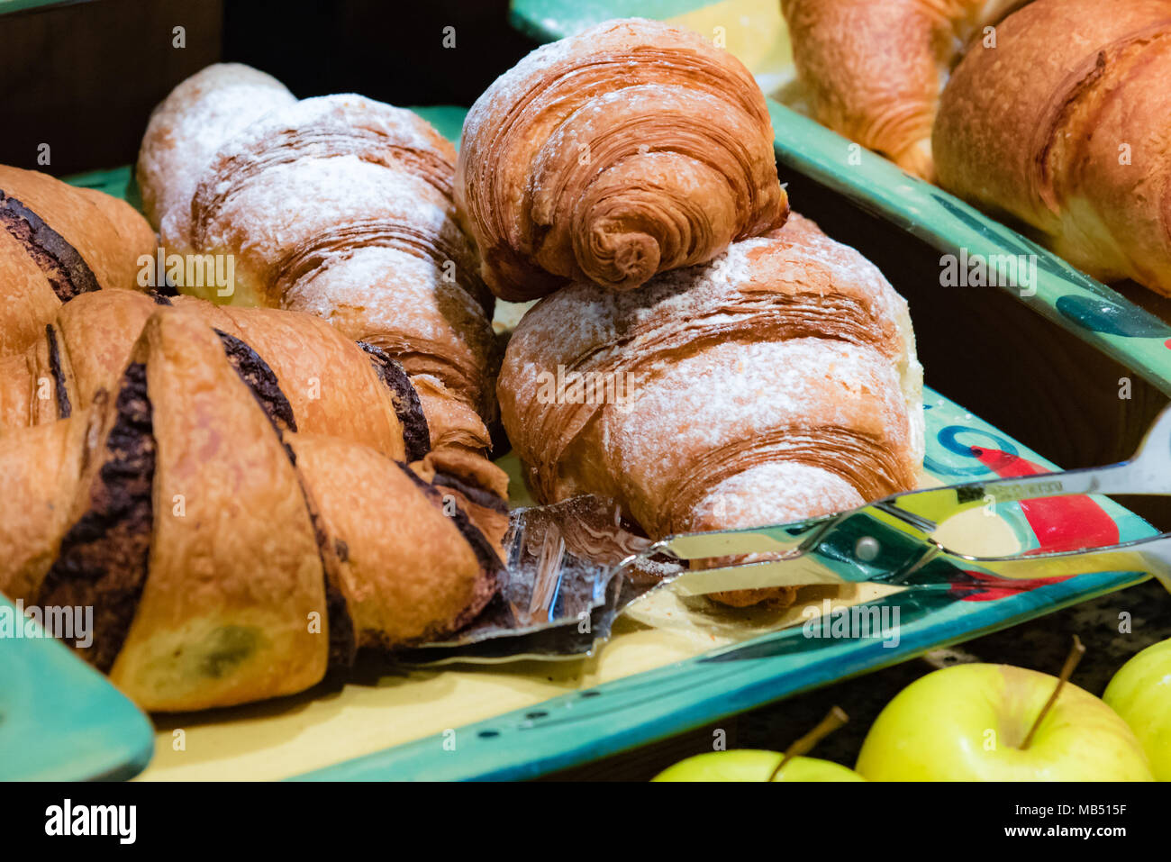 Pile of fresh croissant on a colorful tray. Fresh croissant with ...