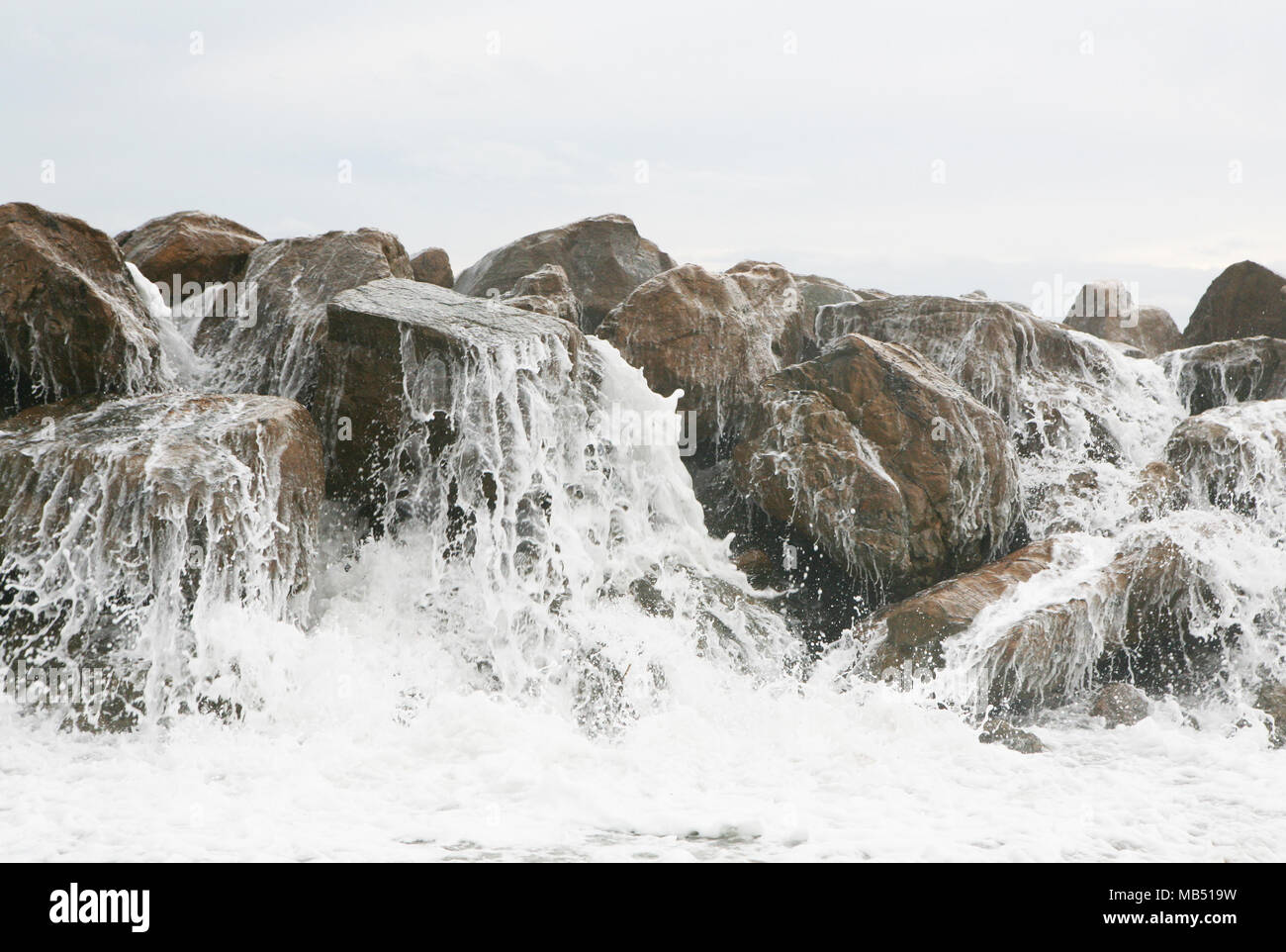 Sea wave breaking on the rocks Stock Photo - Alamy