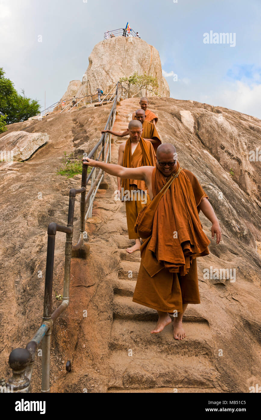 Vertical view of Buddhist monks descending the steep steps of Aradhana ...
