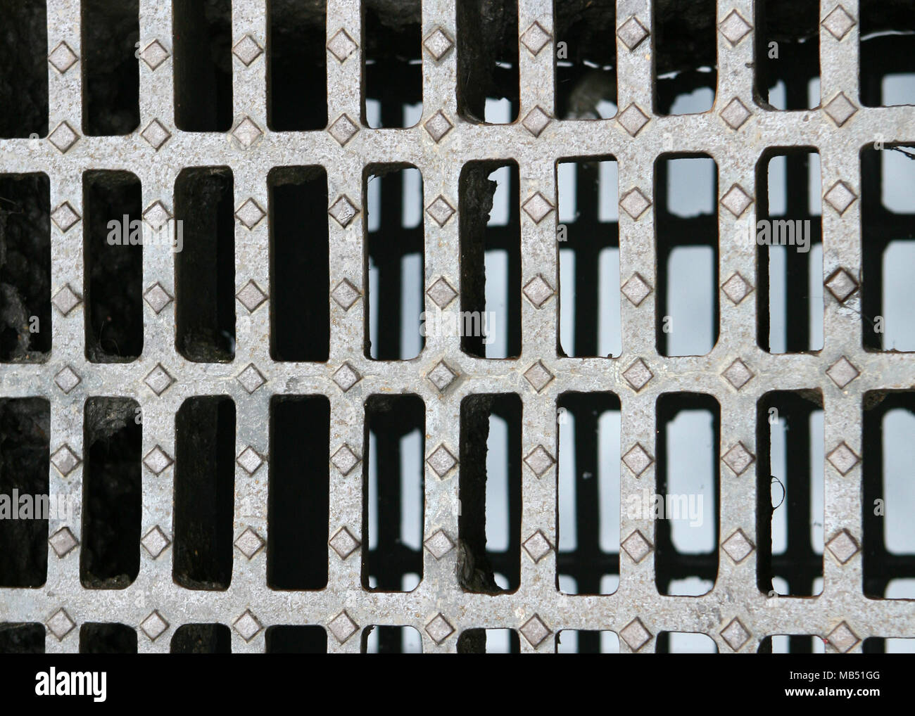 Drain grates with light background texture Stock Photo - Alamy