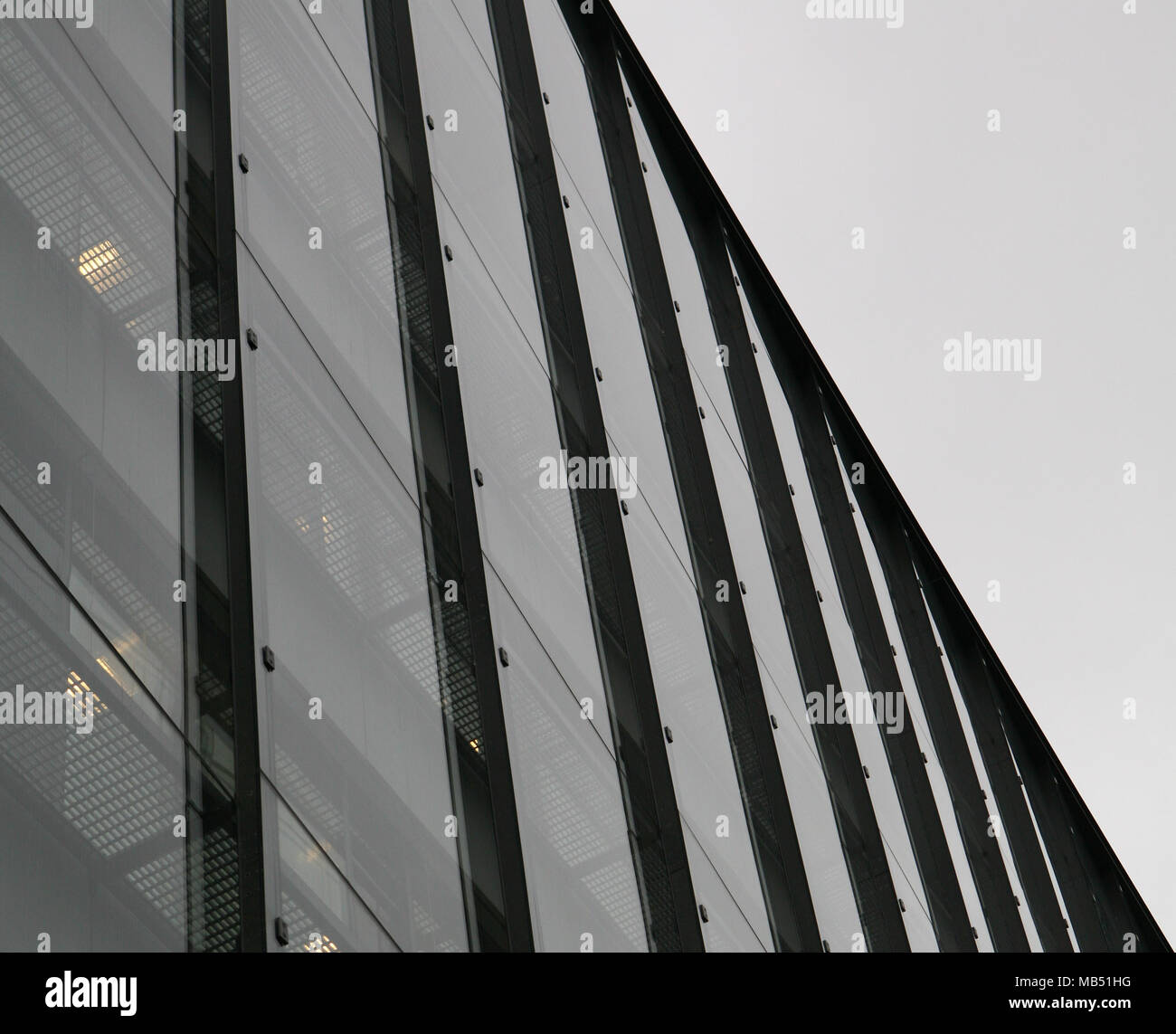Glass and steel building facade on overcast sky Stock Photo - Alamy