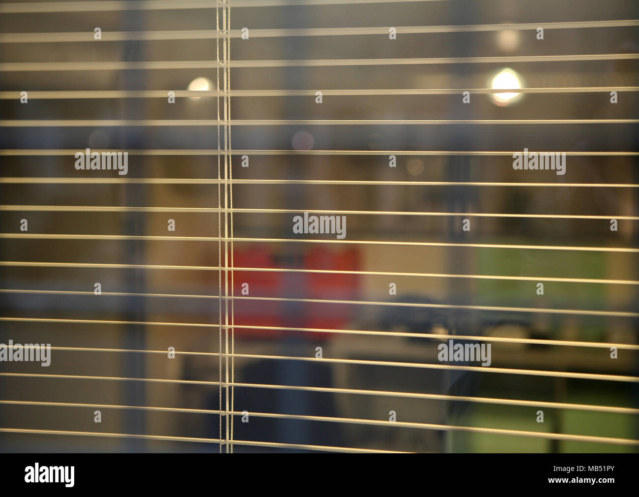 Behind venetian blinds Stock Photo - Alamy