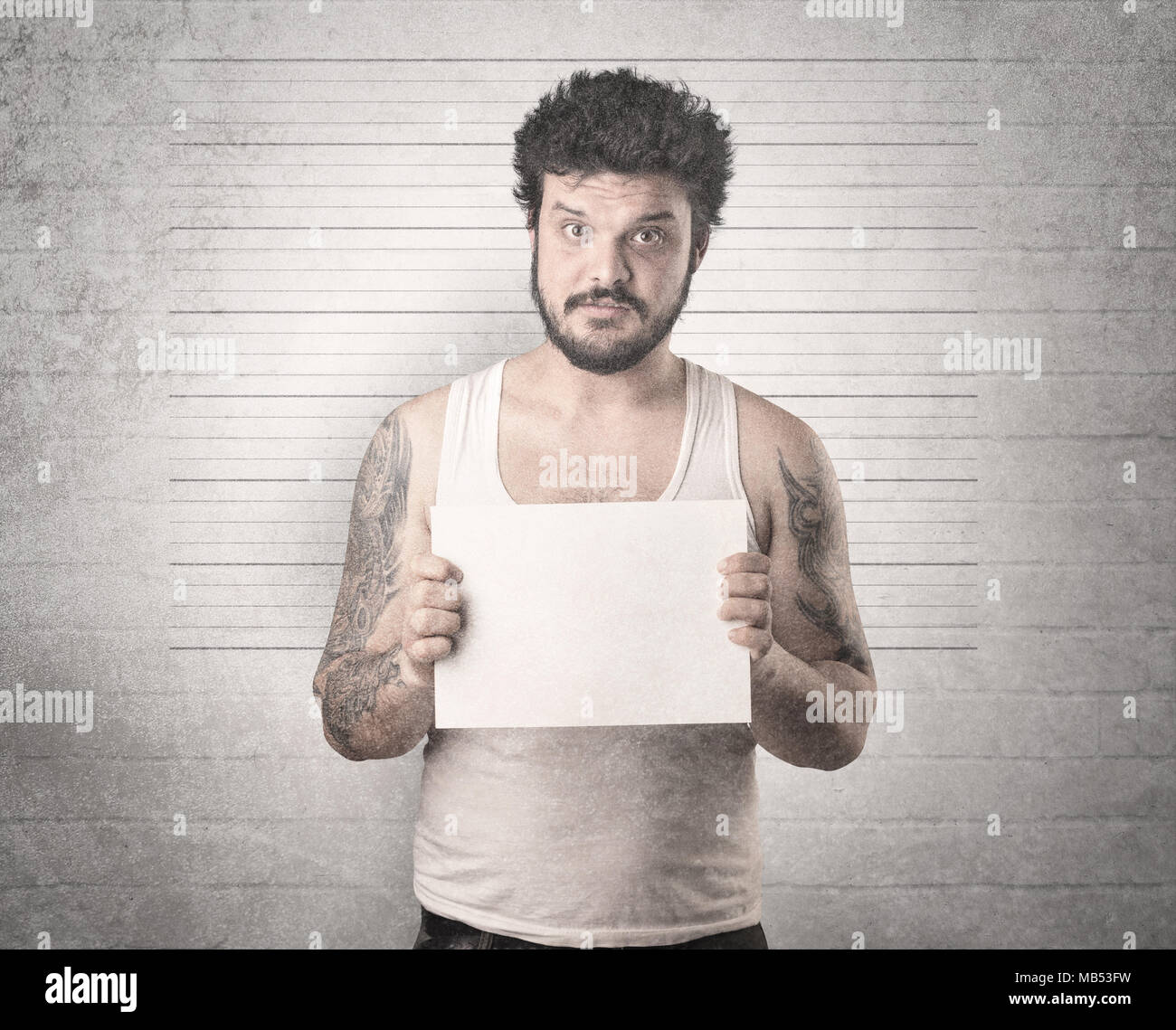 Gangster in front of a wall with table on his hand Stock Photo - Alamy