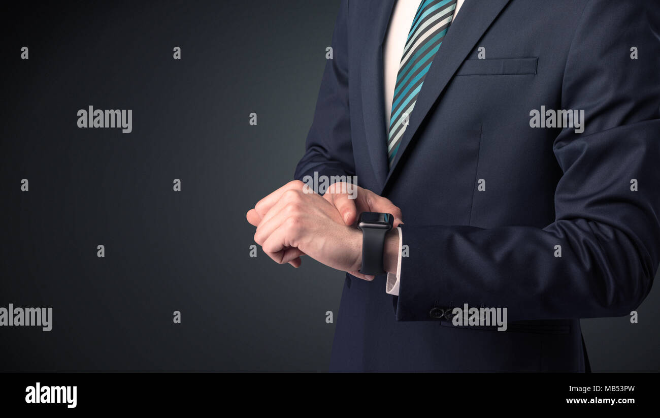 Man wearing suit with smartwatch on his wrist Stock Photo - Alamy