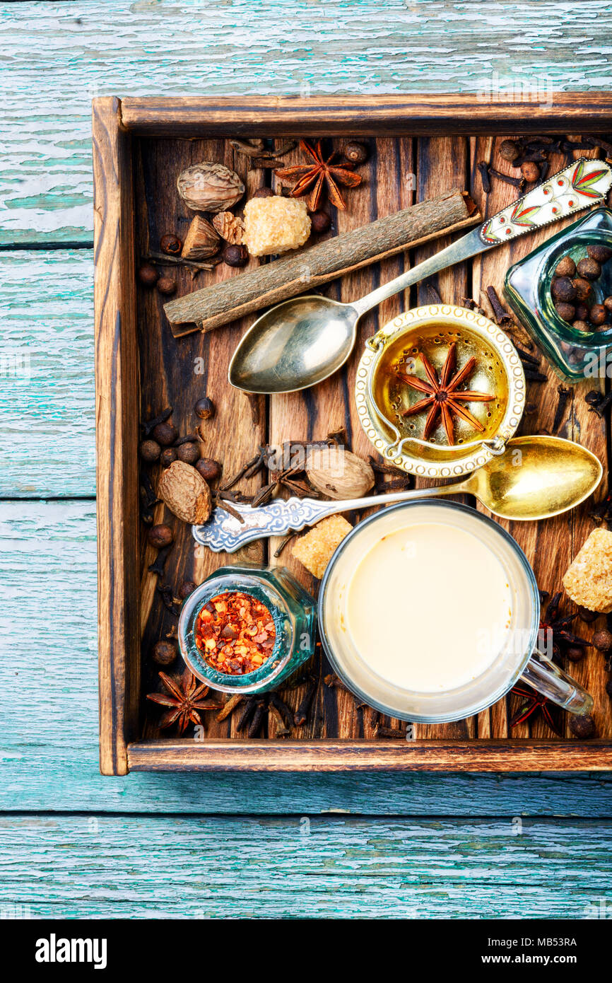 Cup of indian masala tea and spices in a wooden tray.Masala chai Stock ...