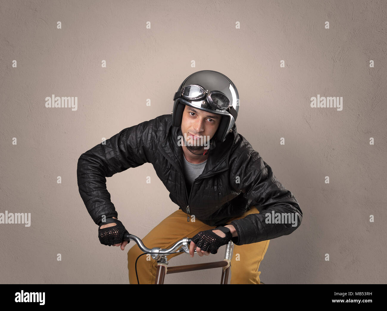 Nerd young foolish biker on a bike with oldschool outfit Stock Photo ...
