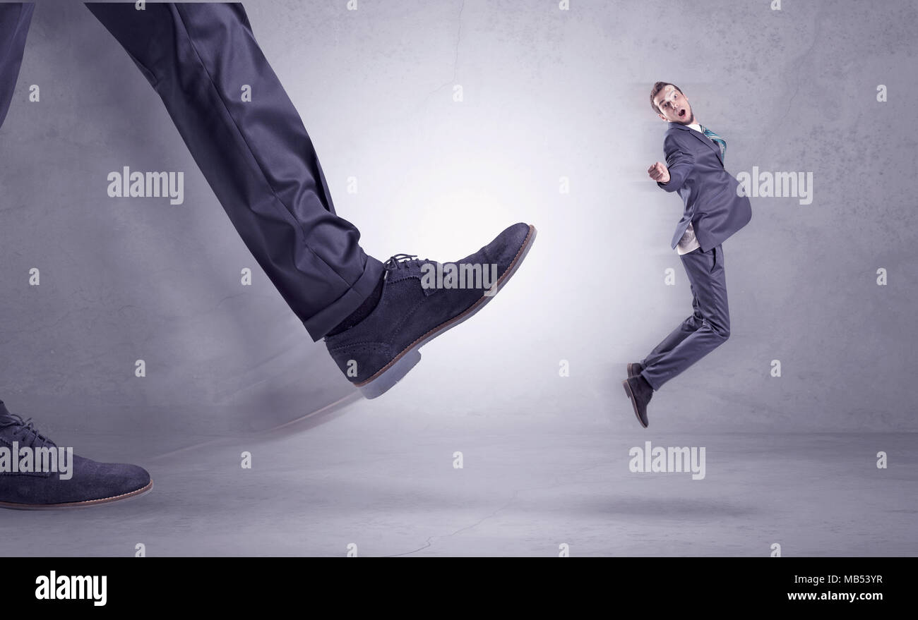 Deported from workplace, big foot kicking small businessman flying away ...