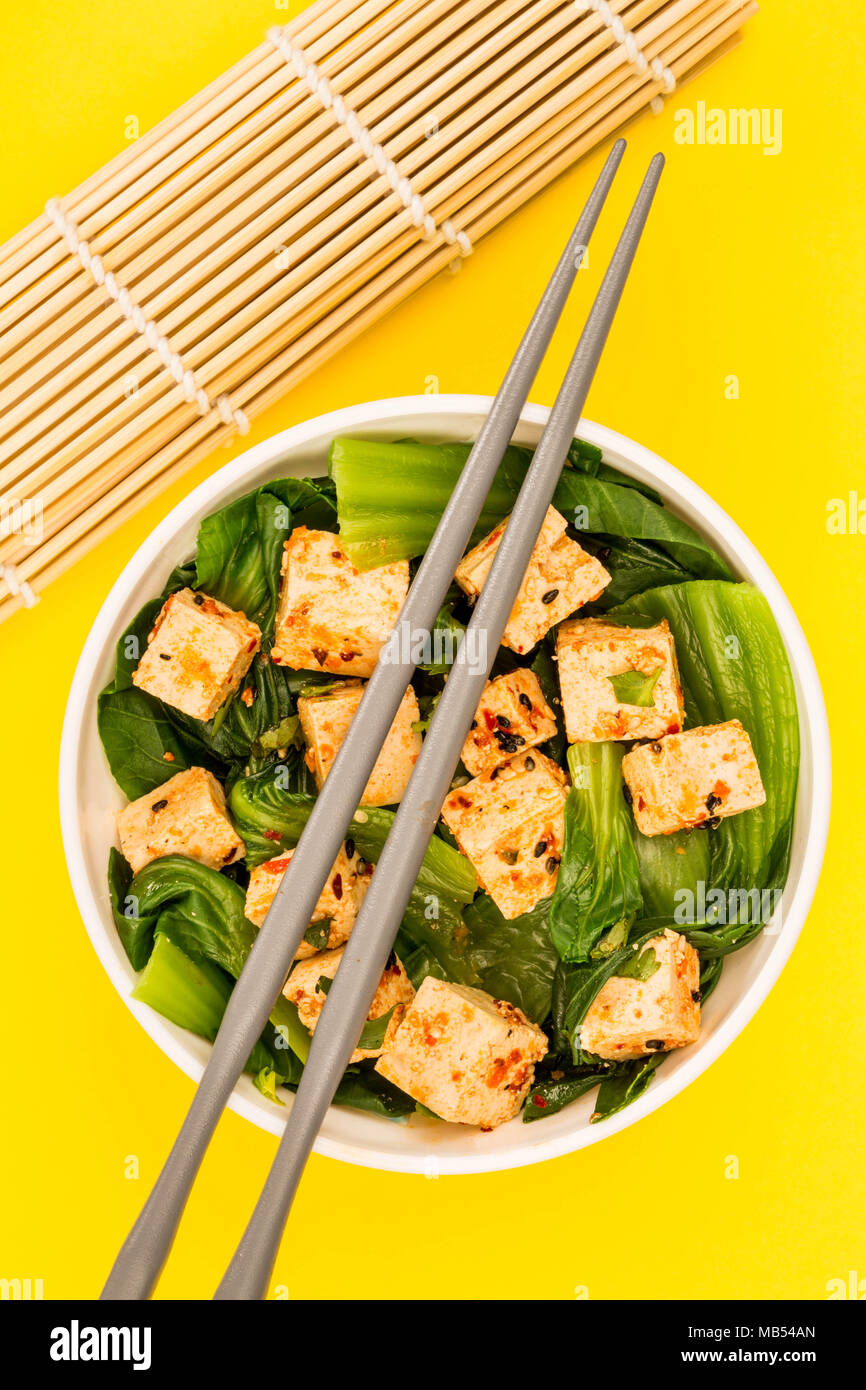 Chinese Style Pak Choi With Tofu Against A Yellow Background Stock ...