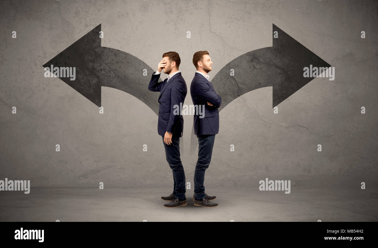 Young conflicted businessman choosing between two directions ...