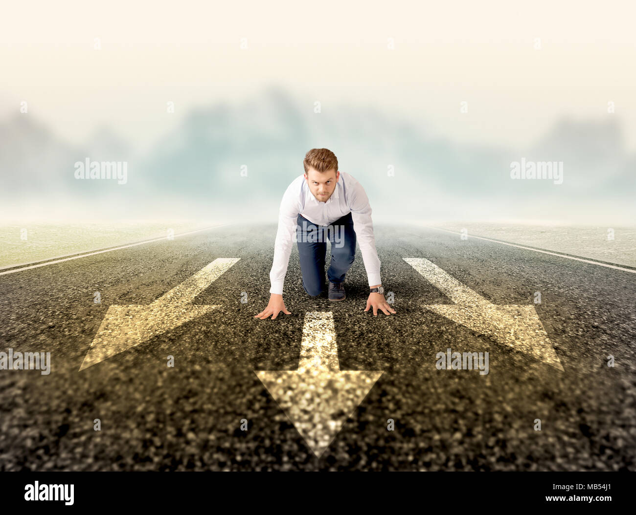 Young determined businessman kneeling before three arrows Stock Photo ...