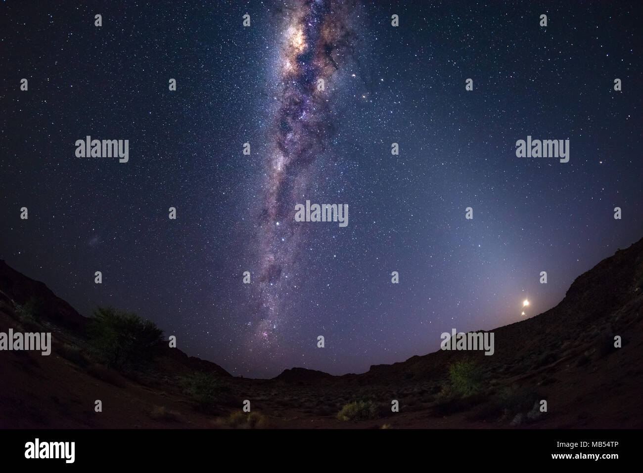 Starry sky and Milky Way arch with moon in the Namib desert in Namibia ...