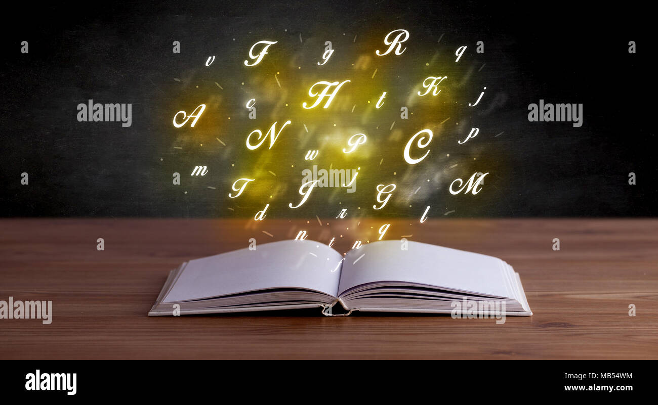 Glowing yellow alphabet letters coming out of an open book Stock Photo ...