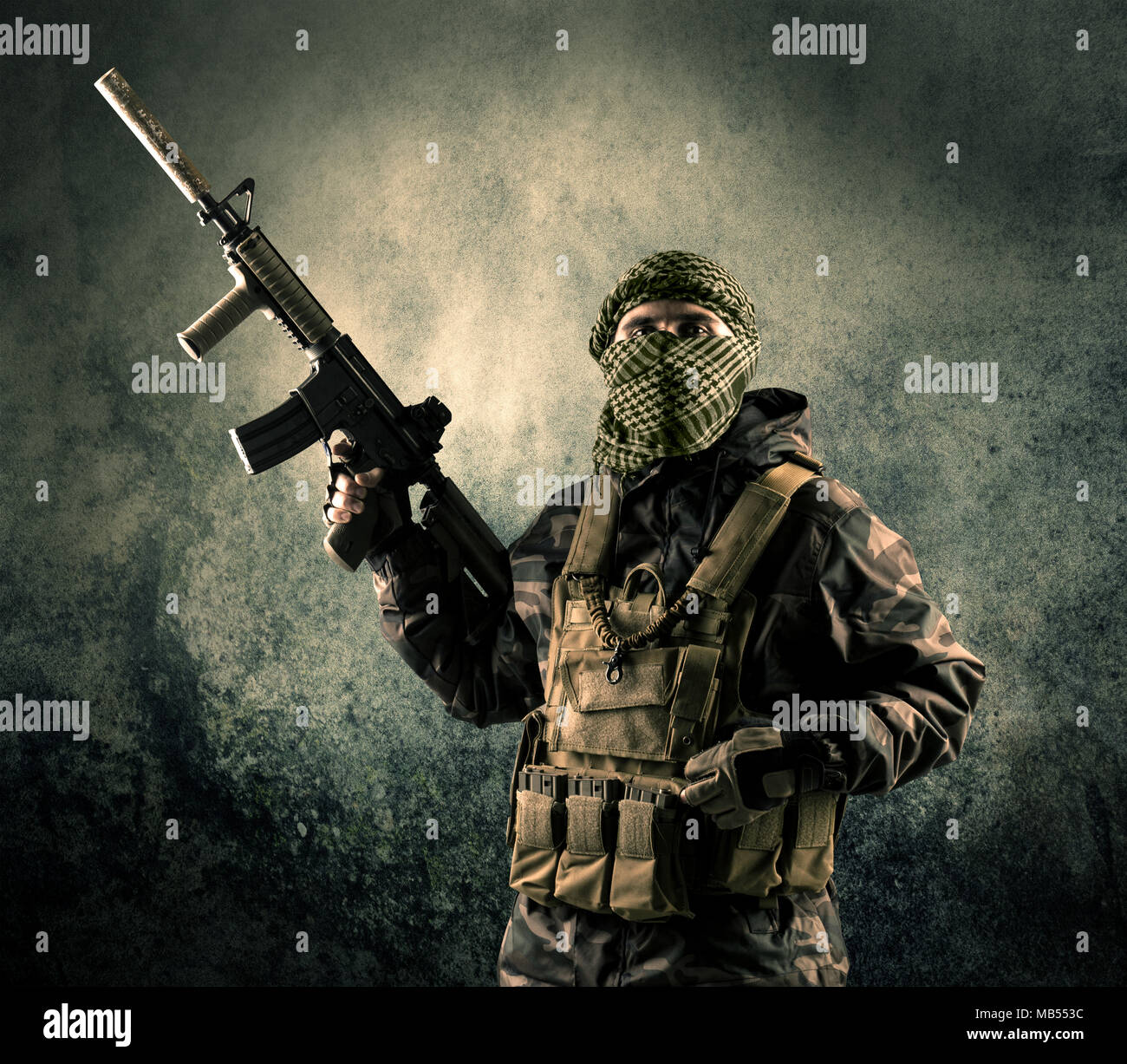 Portrait of a heavily armed masked soldier with grungy background ...