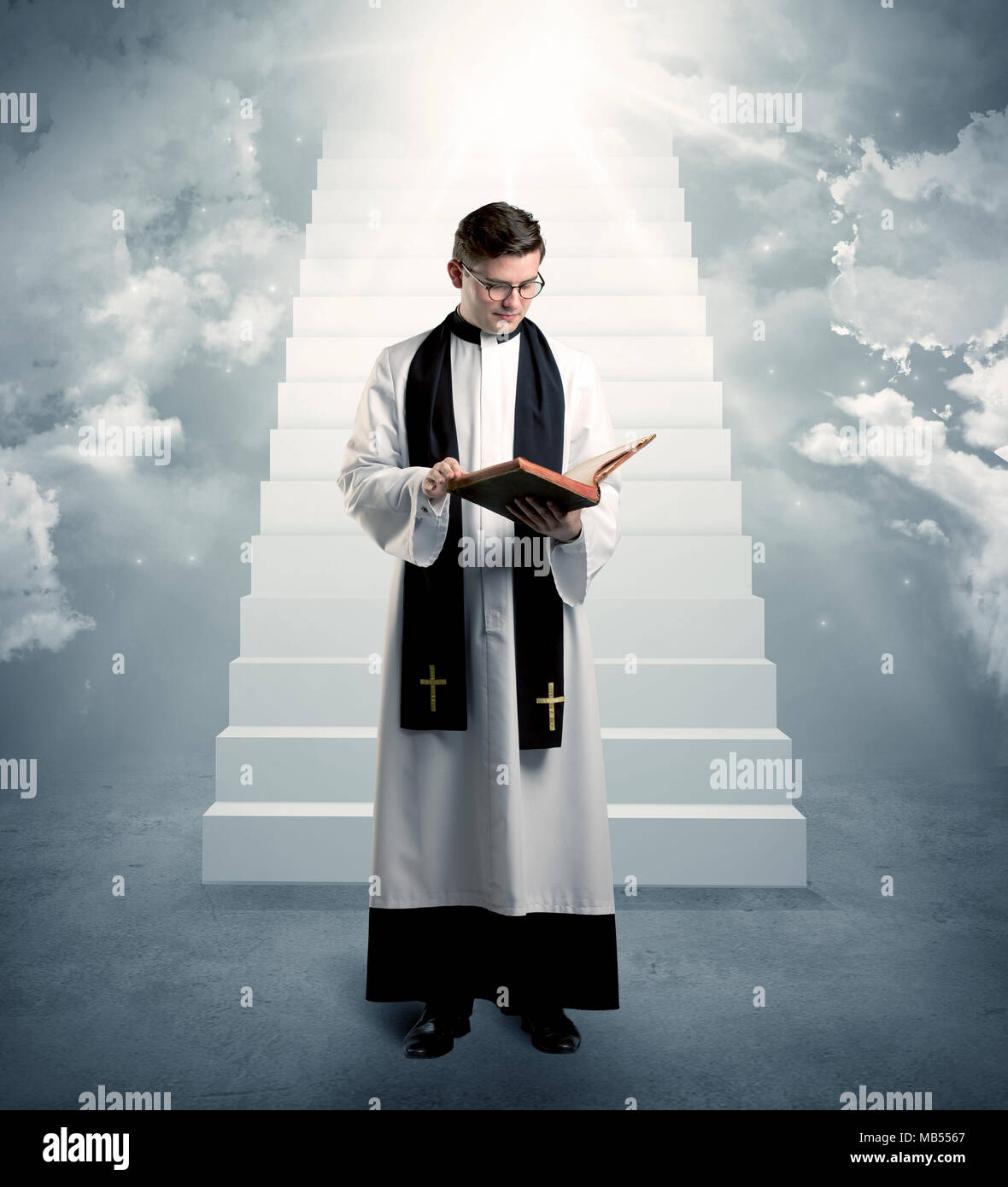 A young religious happy priest standing in front of the stairway to ...
