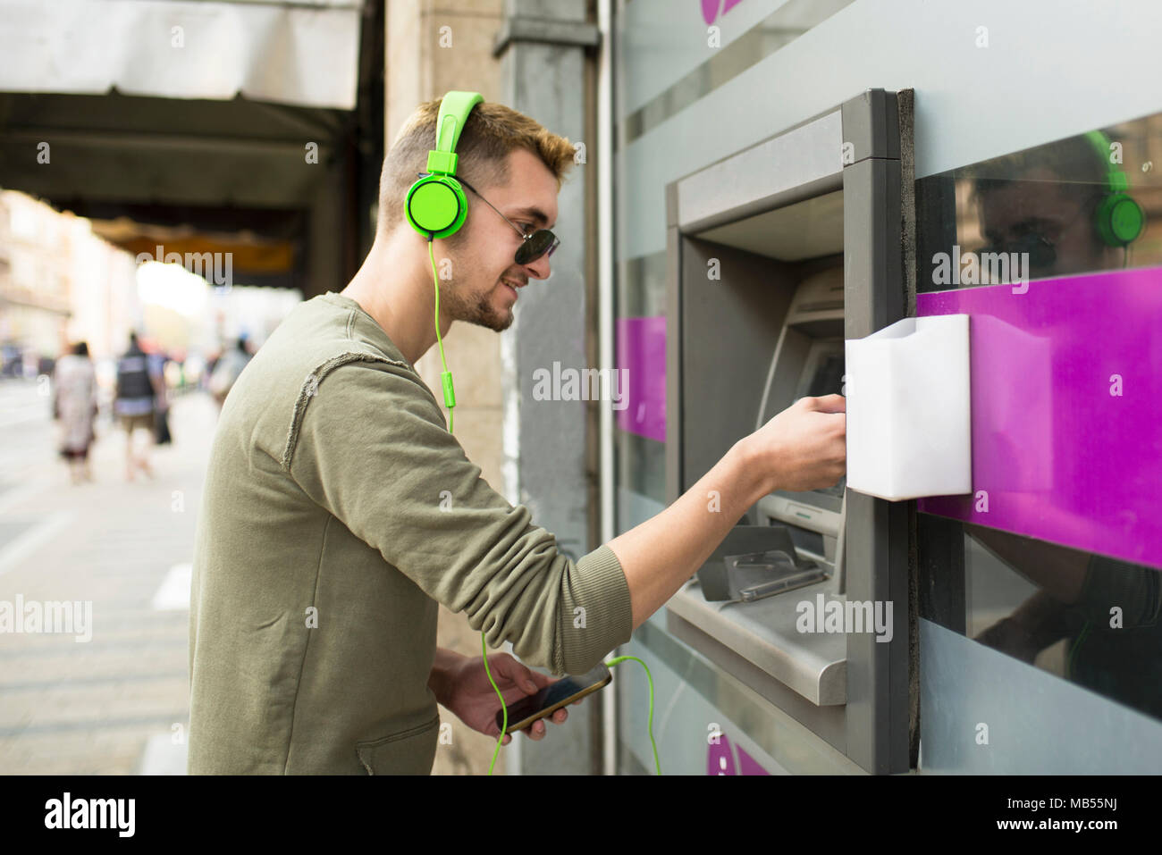 Taking money from cash machine hi-res stock photography and images - Alamy