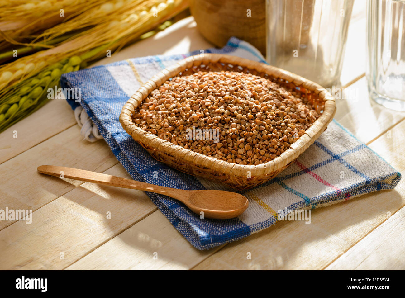 Grechka (buckwheat) in a little plate on a towel put on a wooden table ...