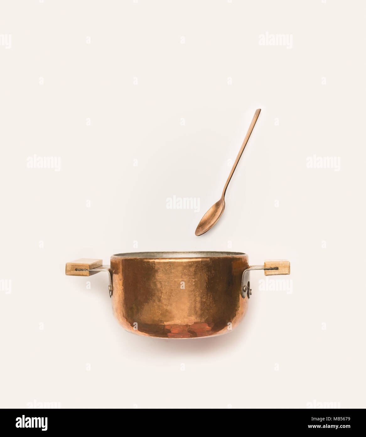 Copper cooking pot with spoon on white background Stock Photo - Alamy