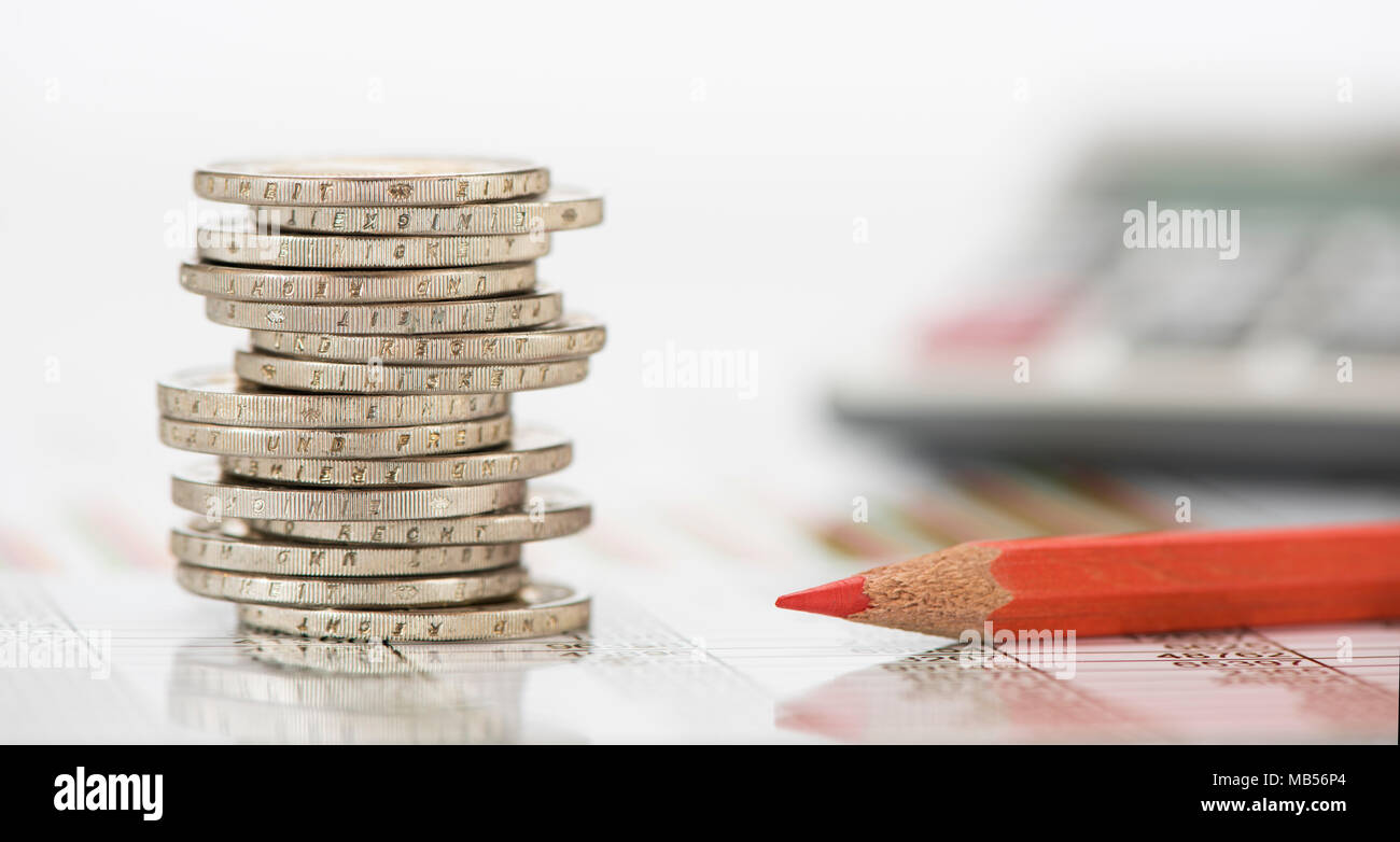 stacked euro coins and calculator laying on financial business chart ...