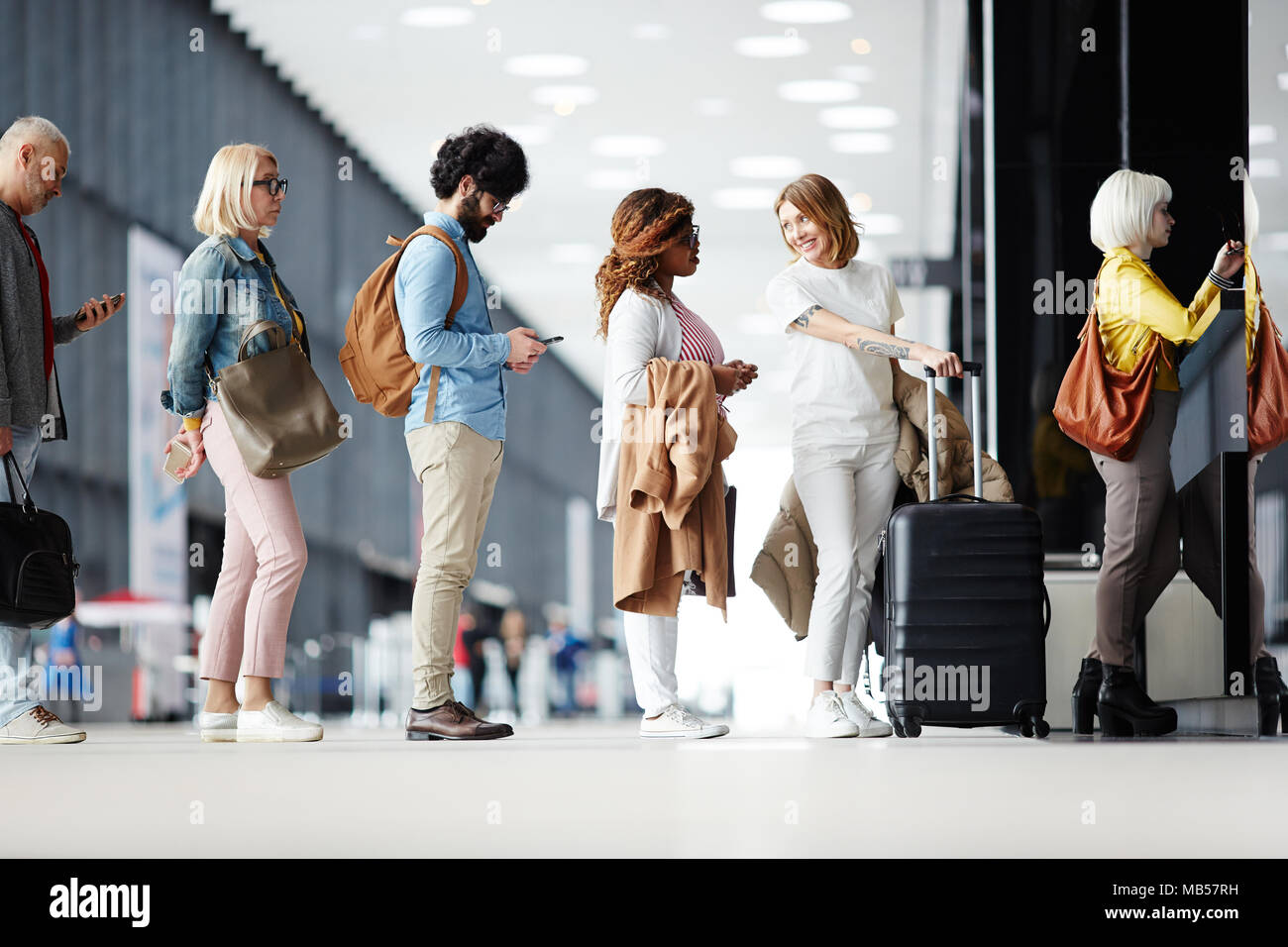 Several passengers standing in queue hi-res stock photography and ...