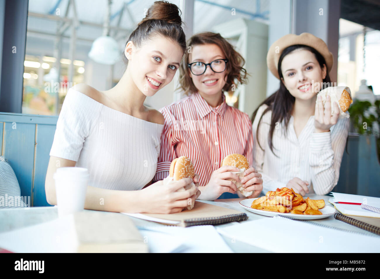 College girl eating fries hi-res stock photography and images - Alamy