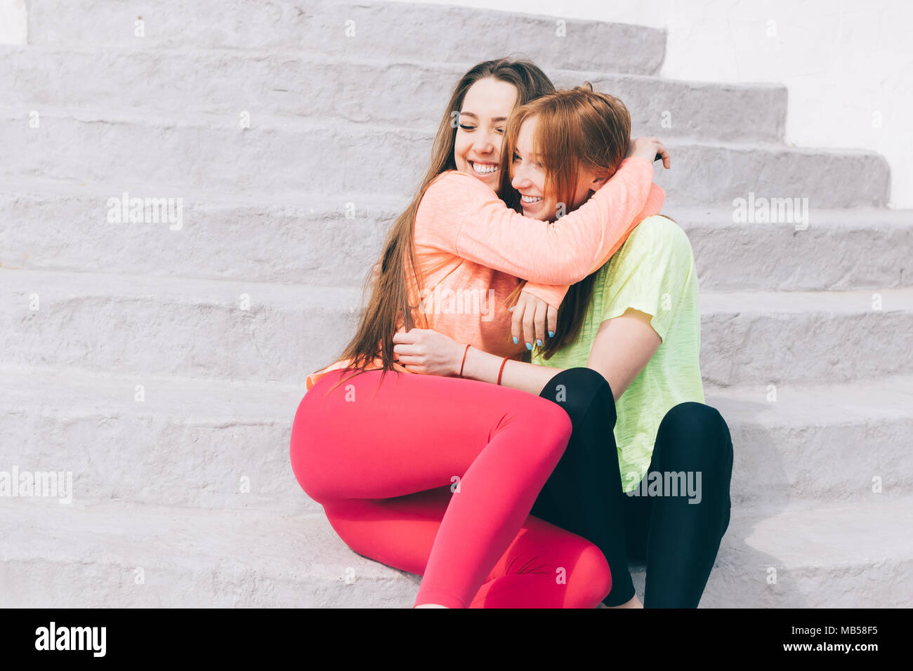 Two people sitting on stairs hi-res stock photography and images - Alamy