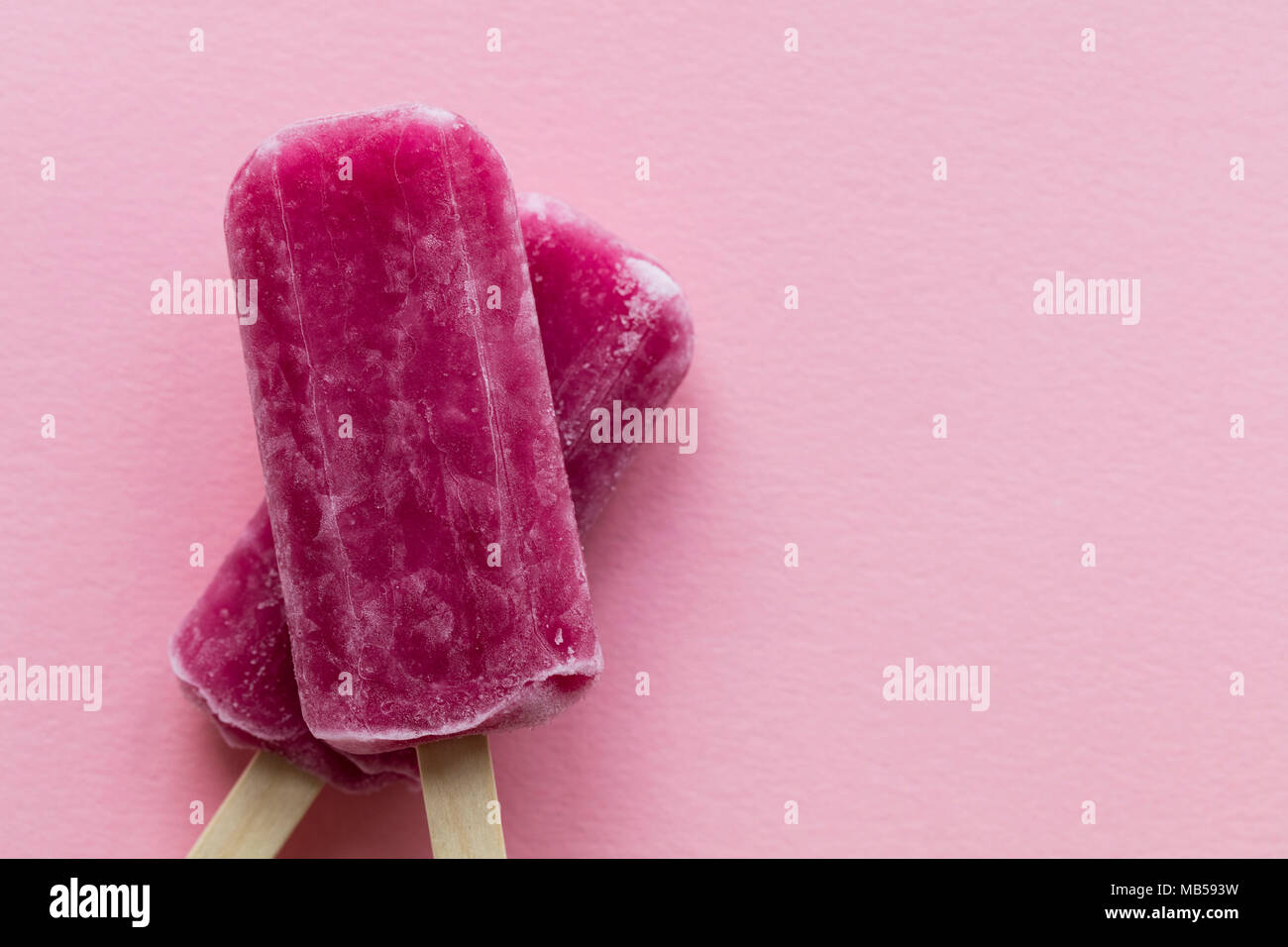 Raspberry flavour summertime ice lollies on a pink background Stock ...