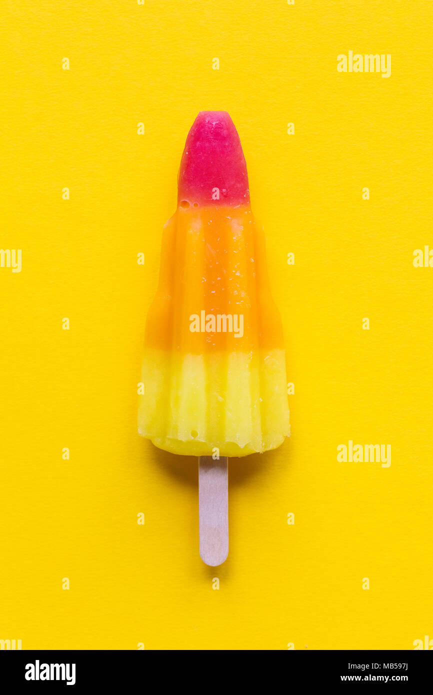 Rocket shaped summer ice lolly on a bright yellow background Stock ...