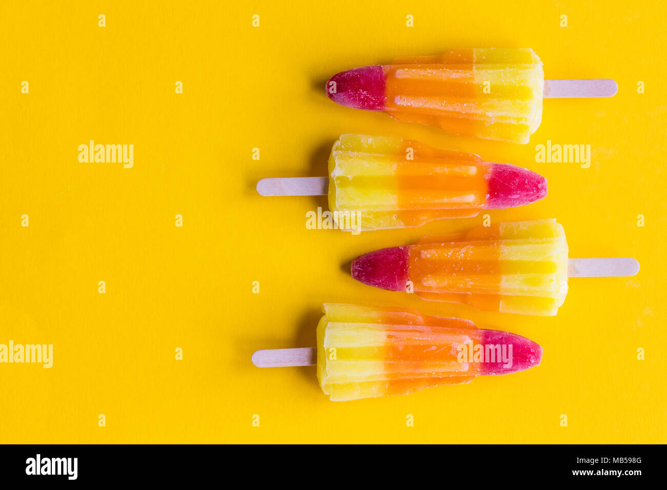 Rocket shaped summer ice lolly on a bright yellow background Stock ...