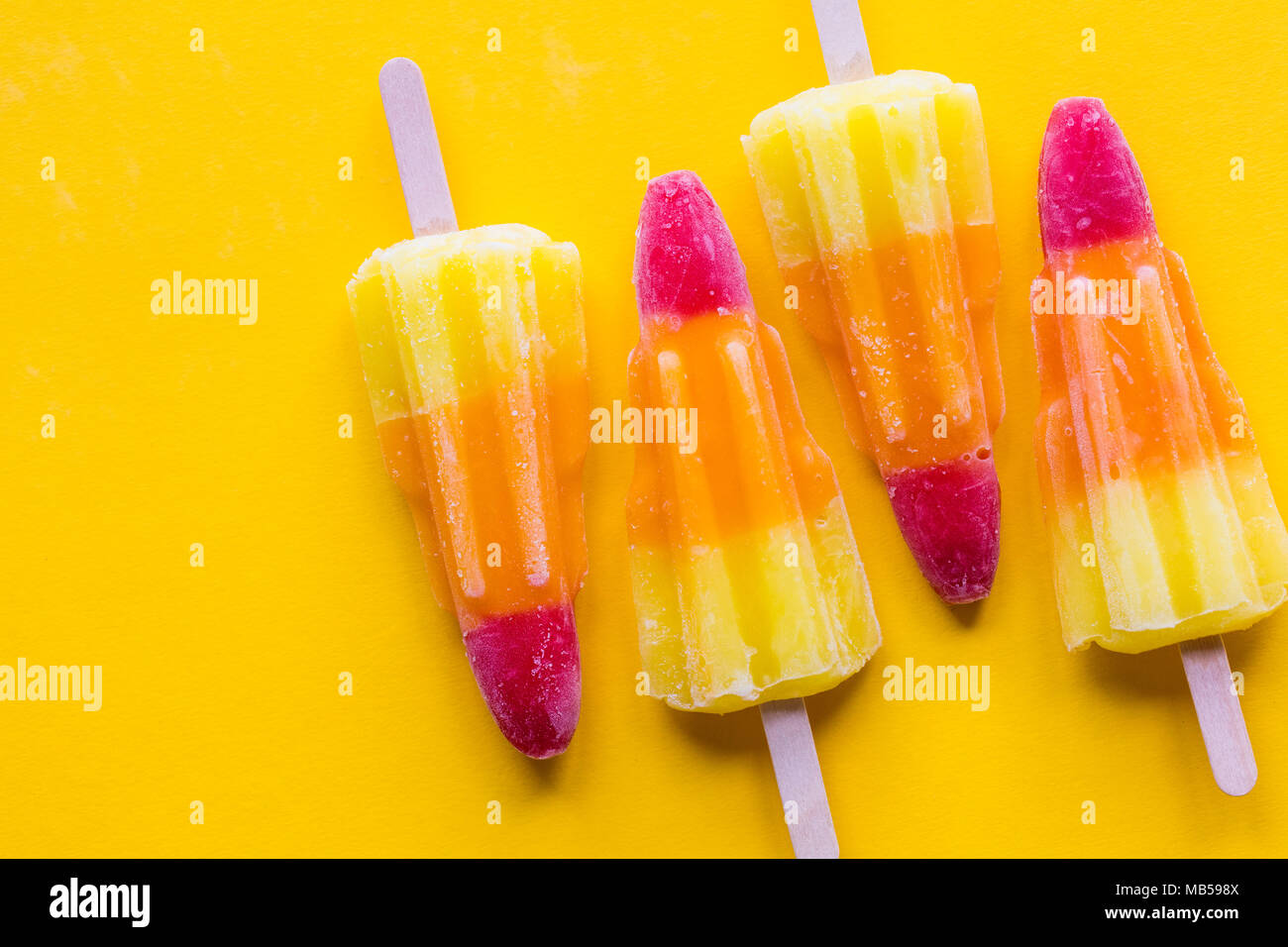 Rocket shaped summer ice lolly on a bright yellow background Stock ...