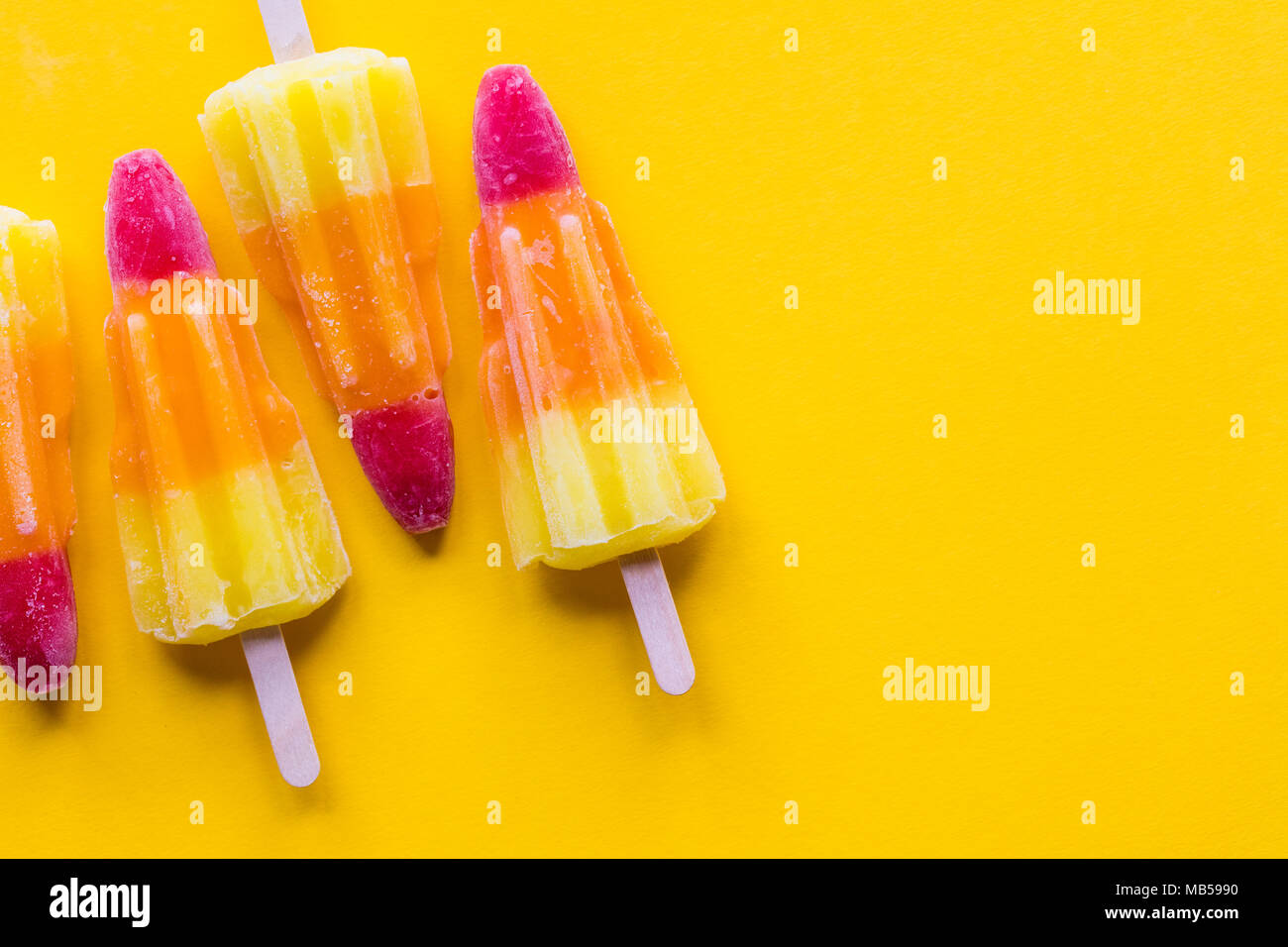 Rocket shaped summer ice lolly on a bright yellow background Stock ...