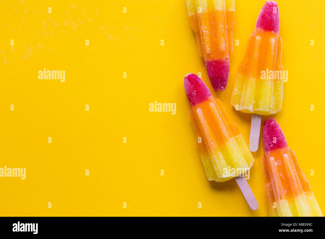 Rocket shaped summer ice lolly on a bright yellow background Stock ...